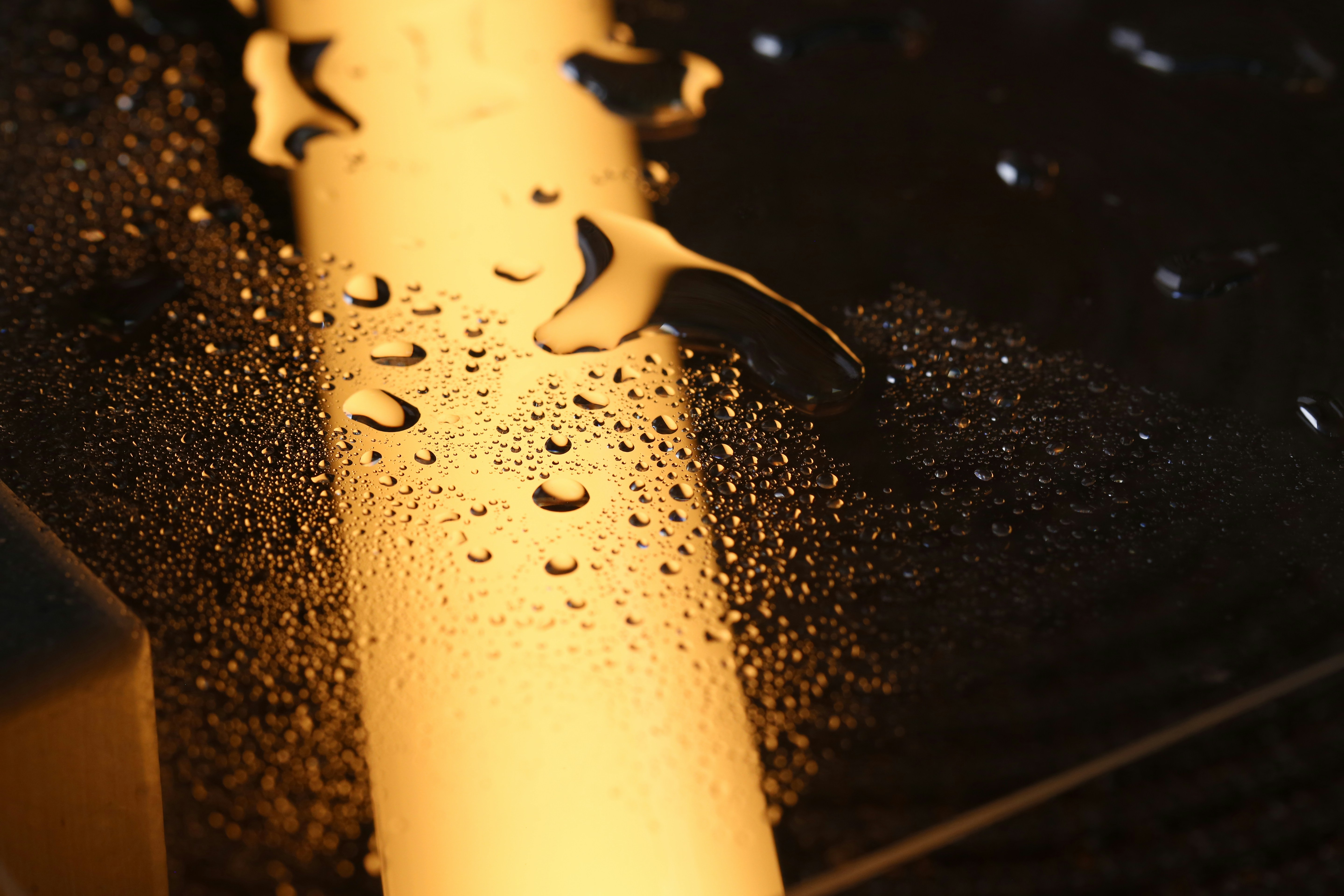Golden Rail Reflections in Rain-Dusted Night