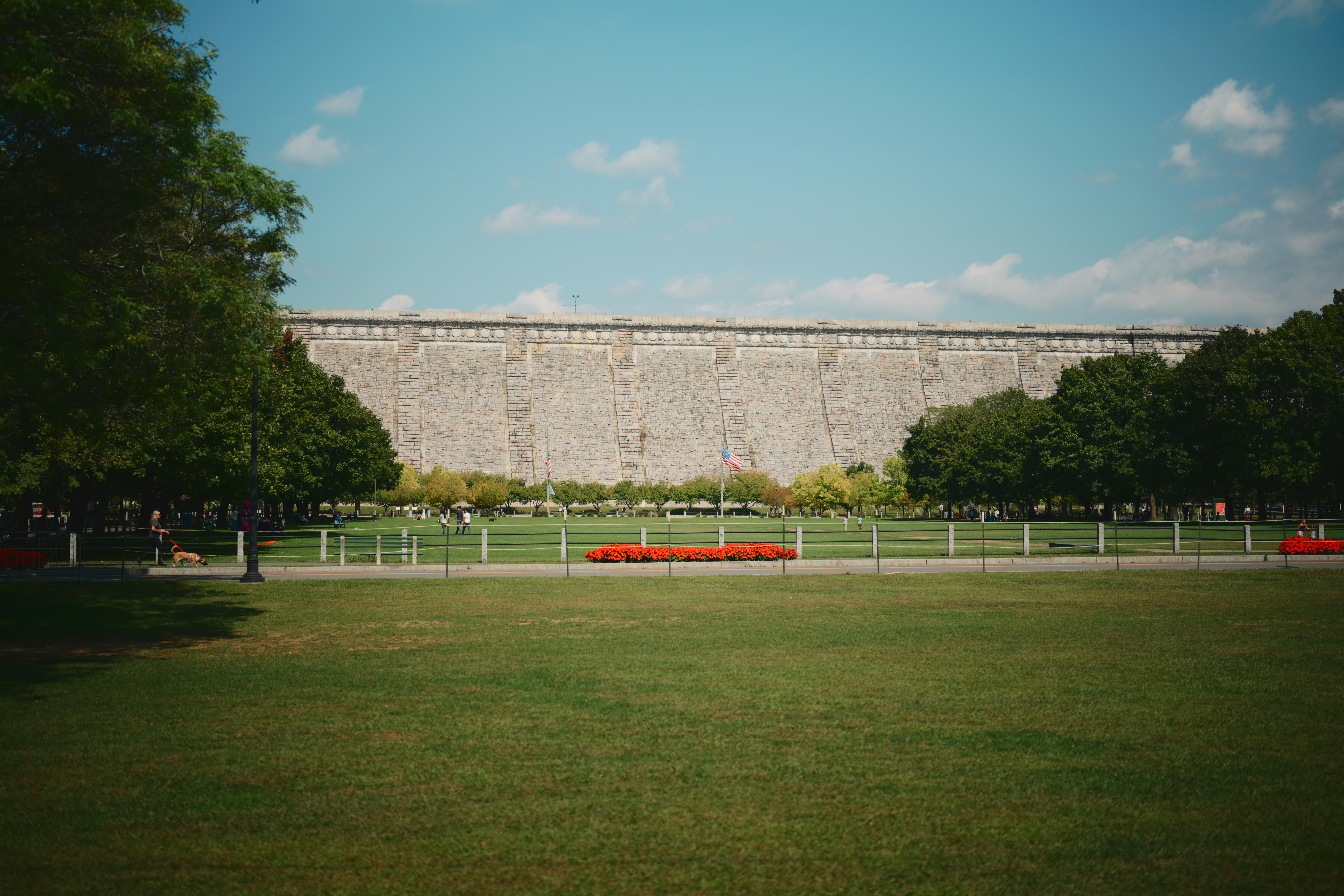 Green Lawn, Stone Barrier, and a Clear Sky