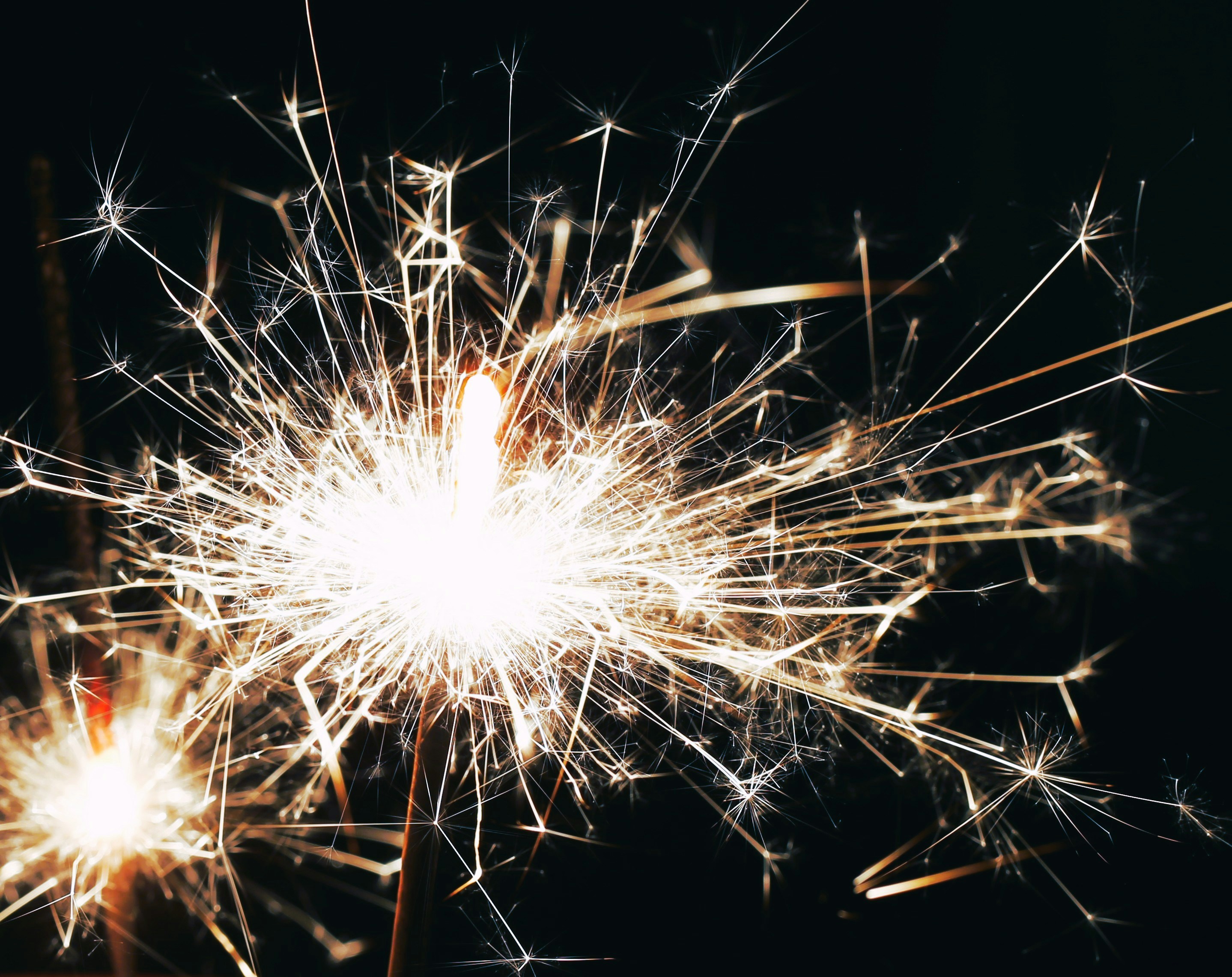 Spark of Dawn: A Close-Up of a Sparkler's Burst