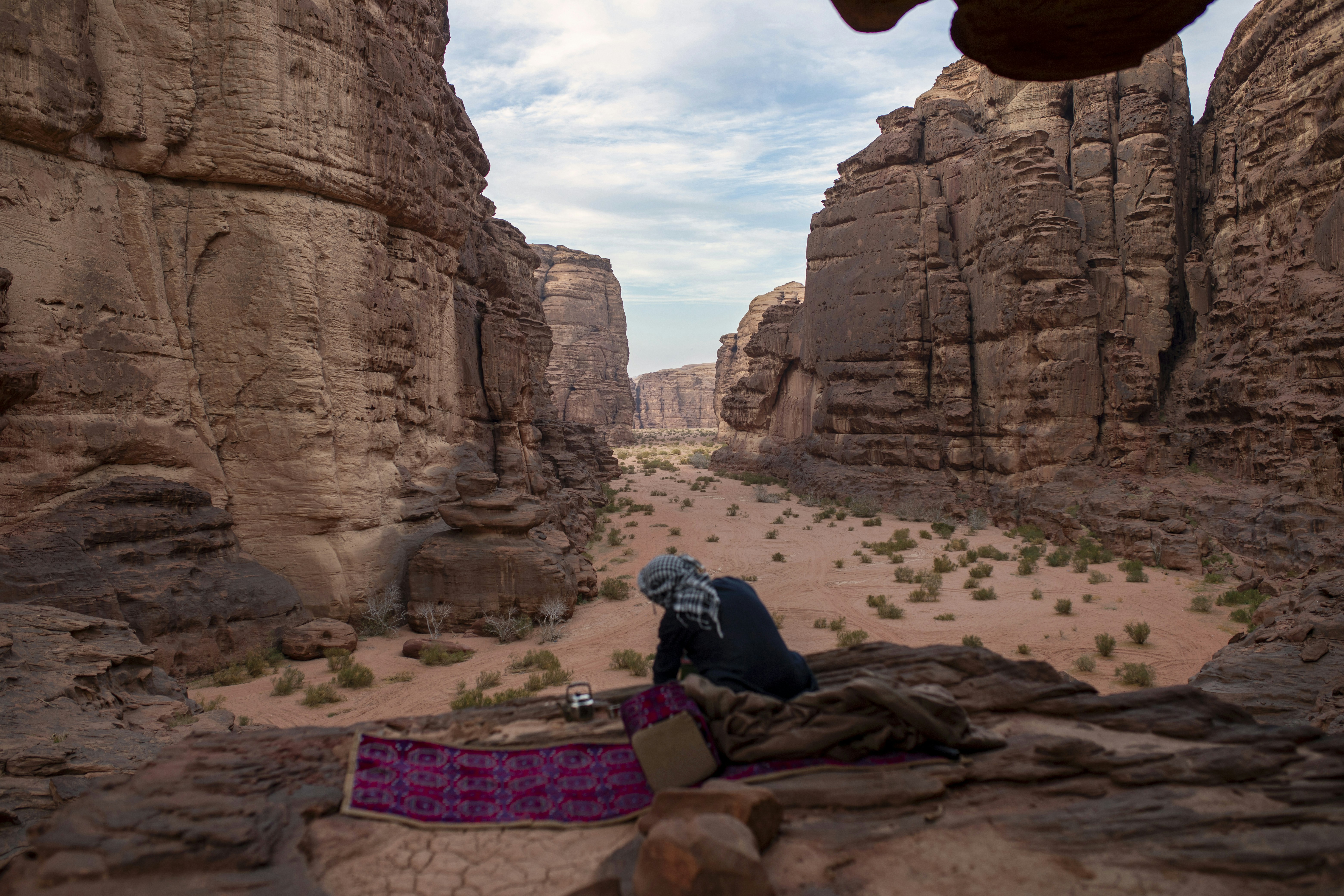 Desert Cliff Quiet: A Camper Sits Within Ancient Gorges