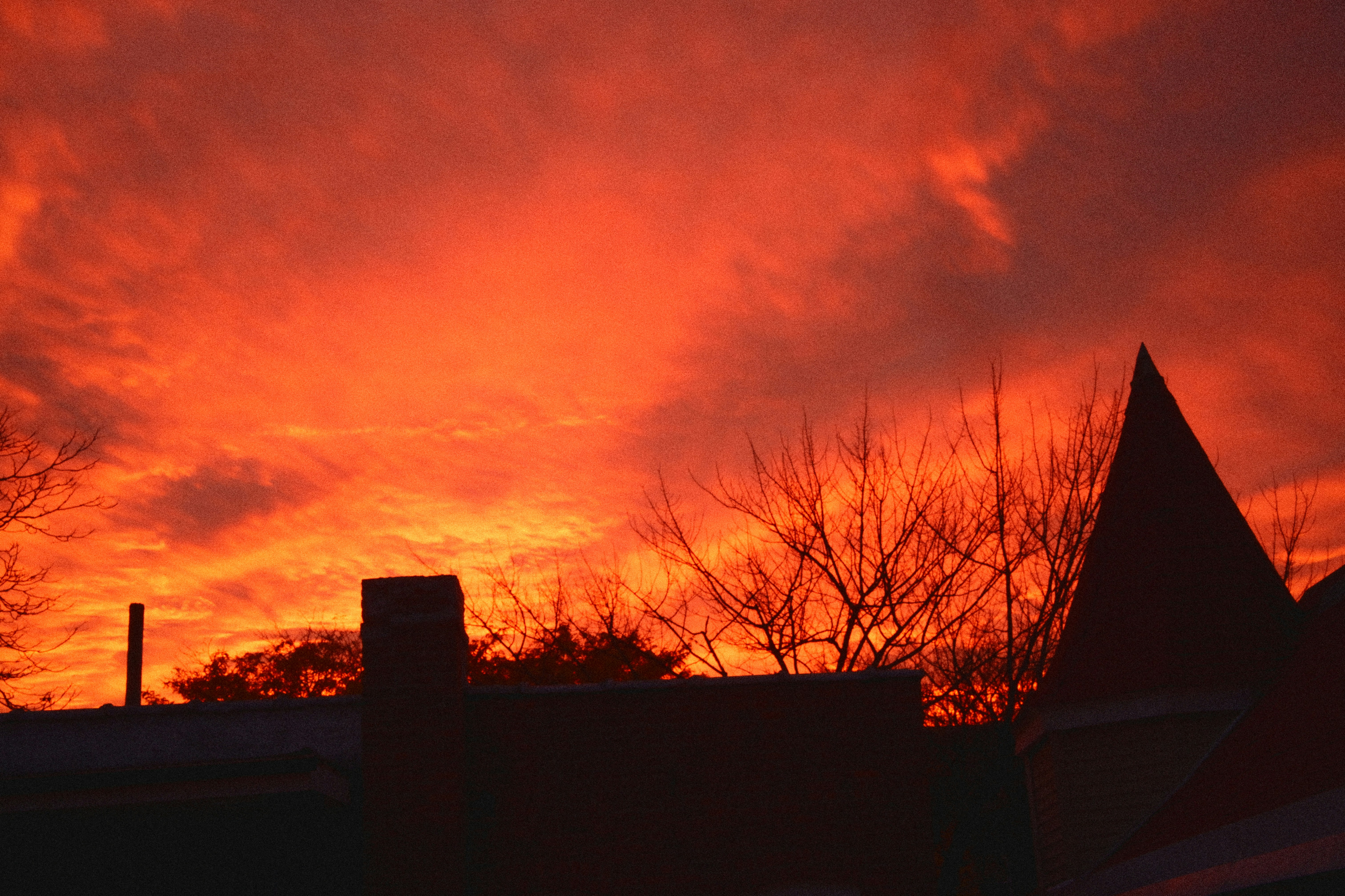 Crimson Skyline: Sunset Over Quiet Rooftops