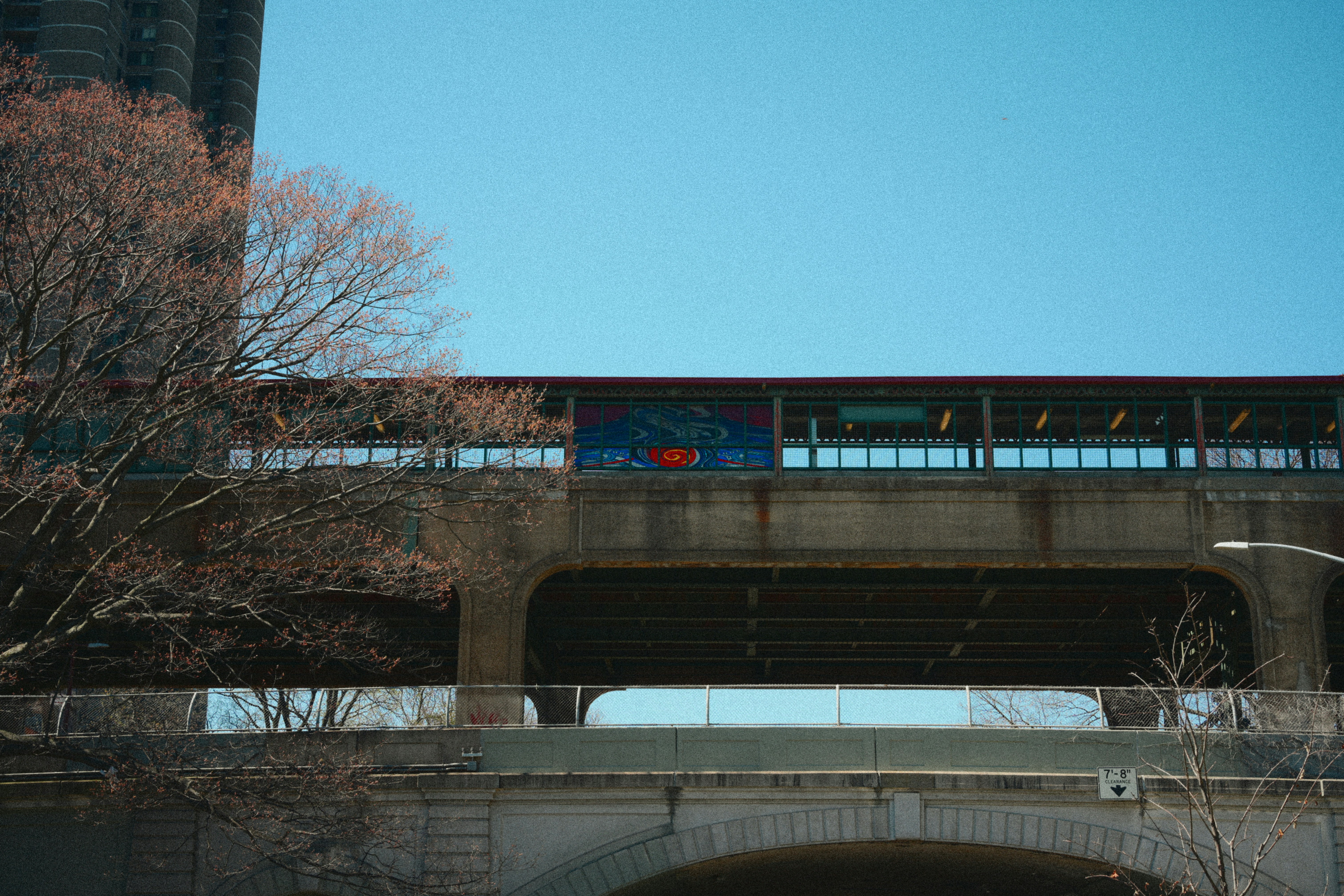Overpass Echoes: City Rail Arches Under a Clear Sky