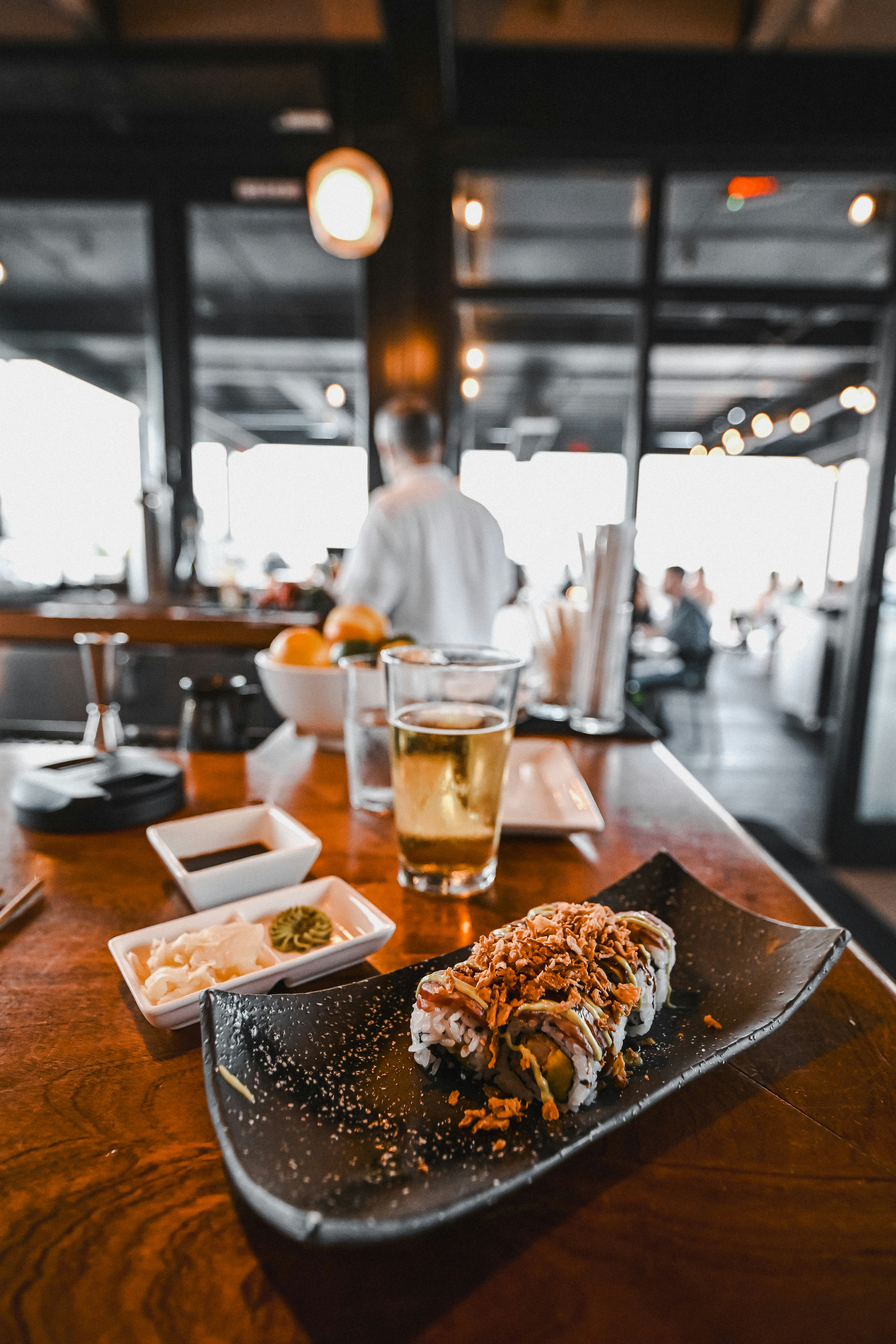Sushi on a Wooden Stage: A Quiet Moment at the Busy Bar