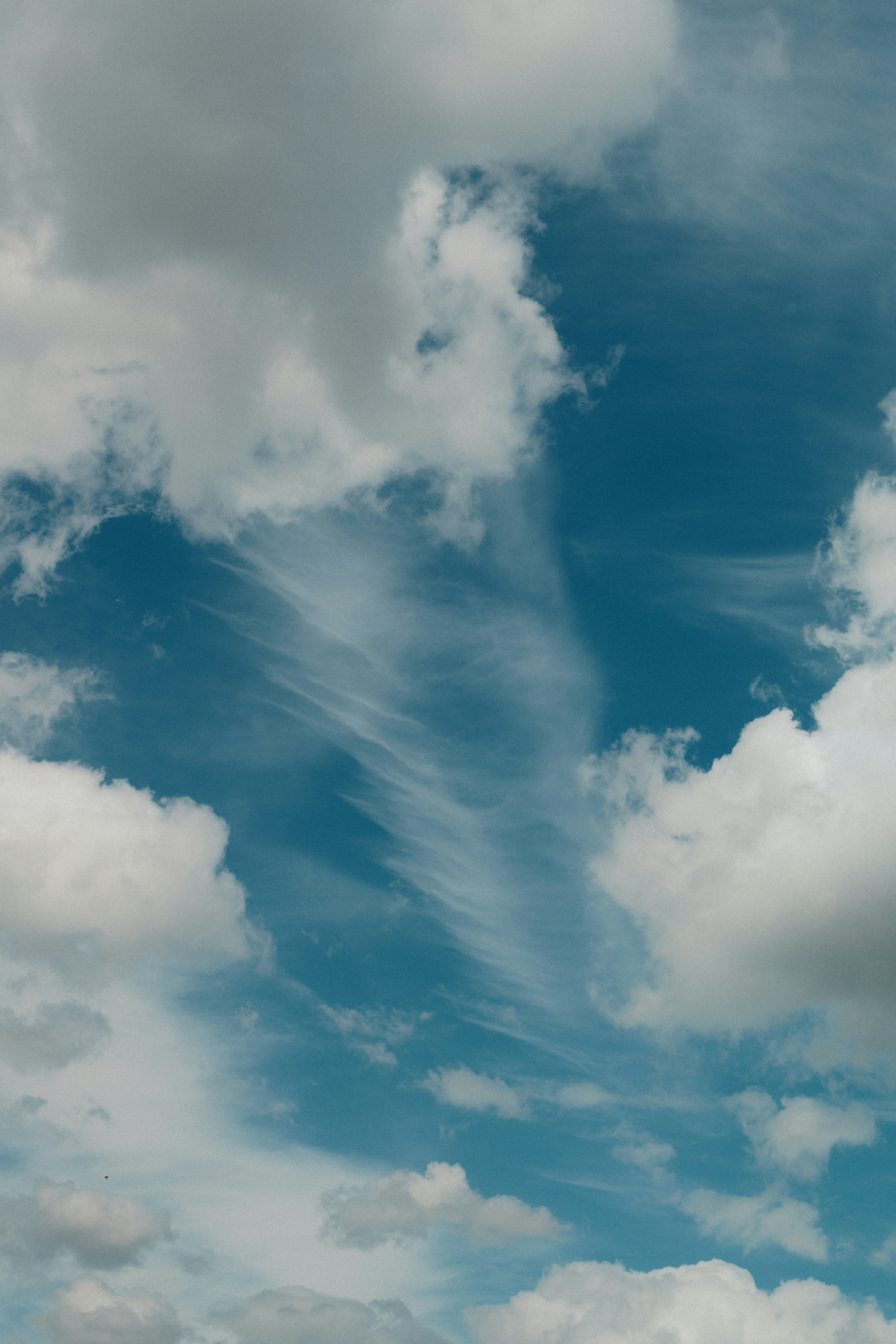 Skybound Veil: A Patchwork of Clouds Beneath a Crisp Blue Corridor