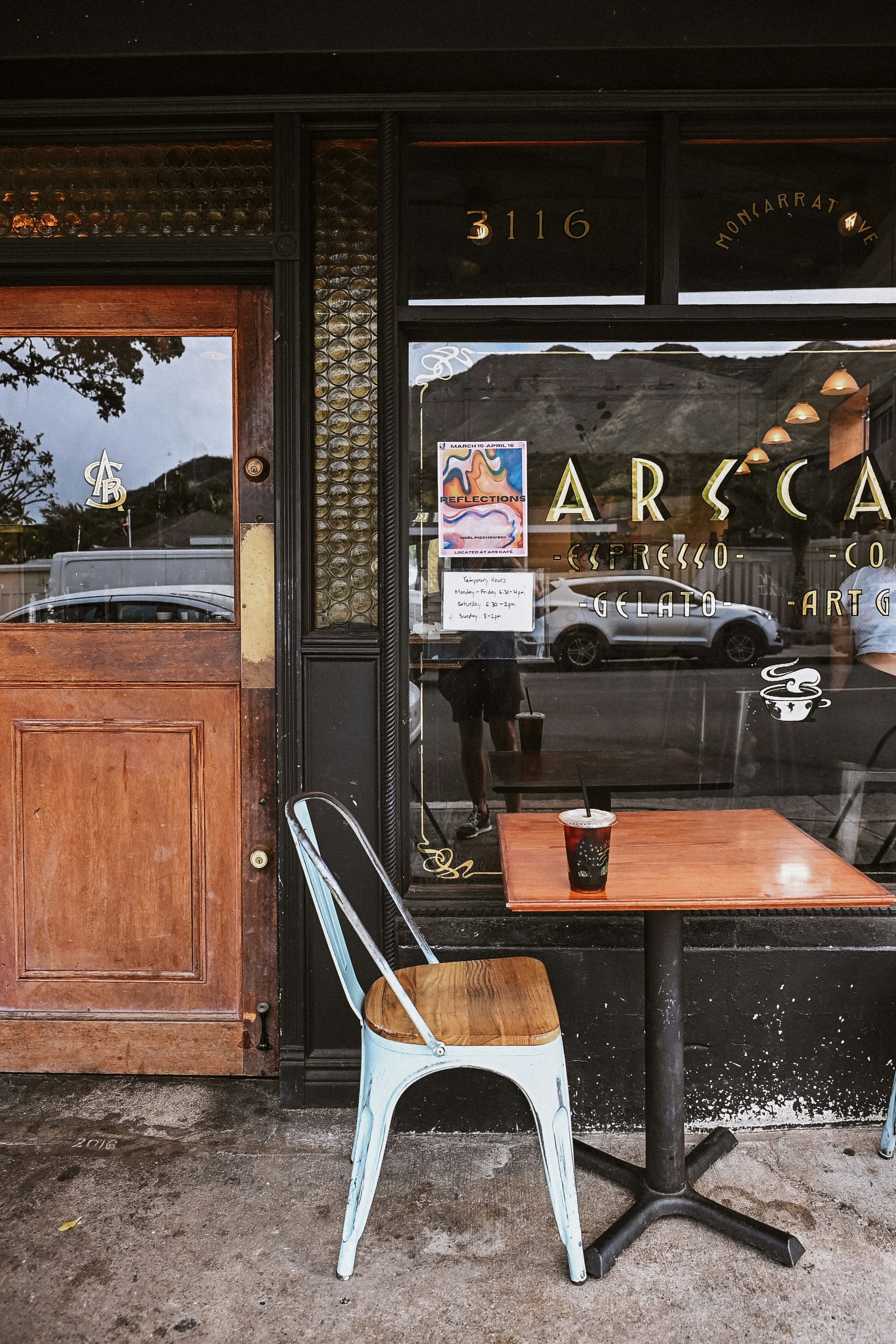 Cafe Corner: Wooden Door, Metal Chair, and Cup on a Table