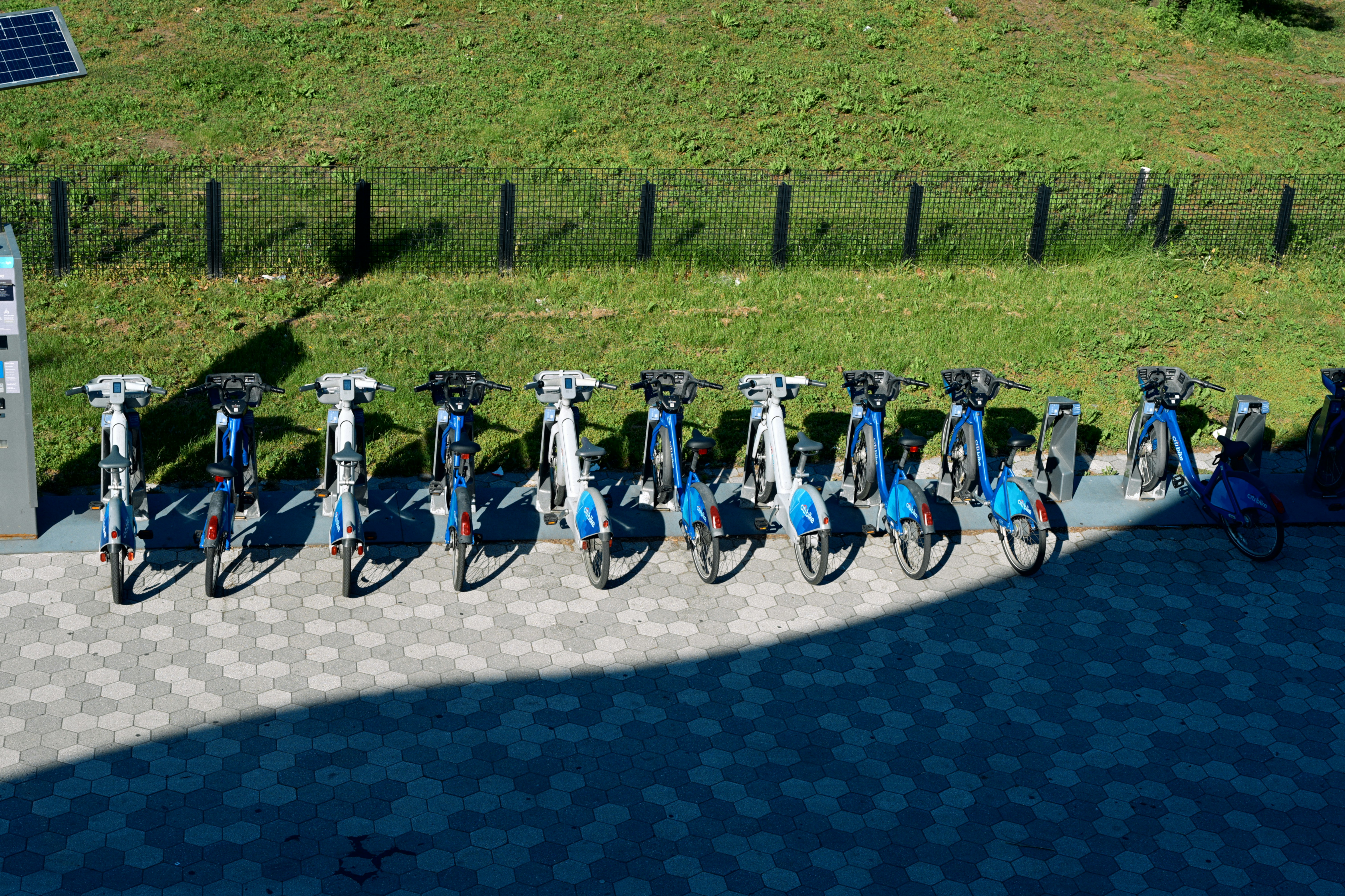 A row of rental bicycles parked at a station.