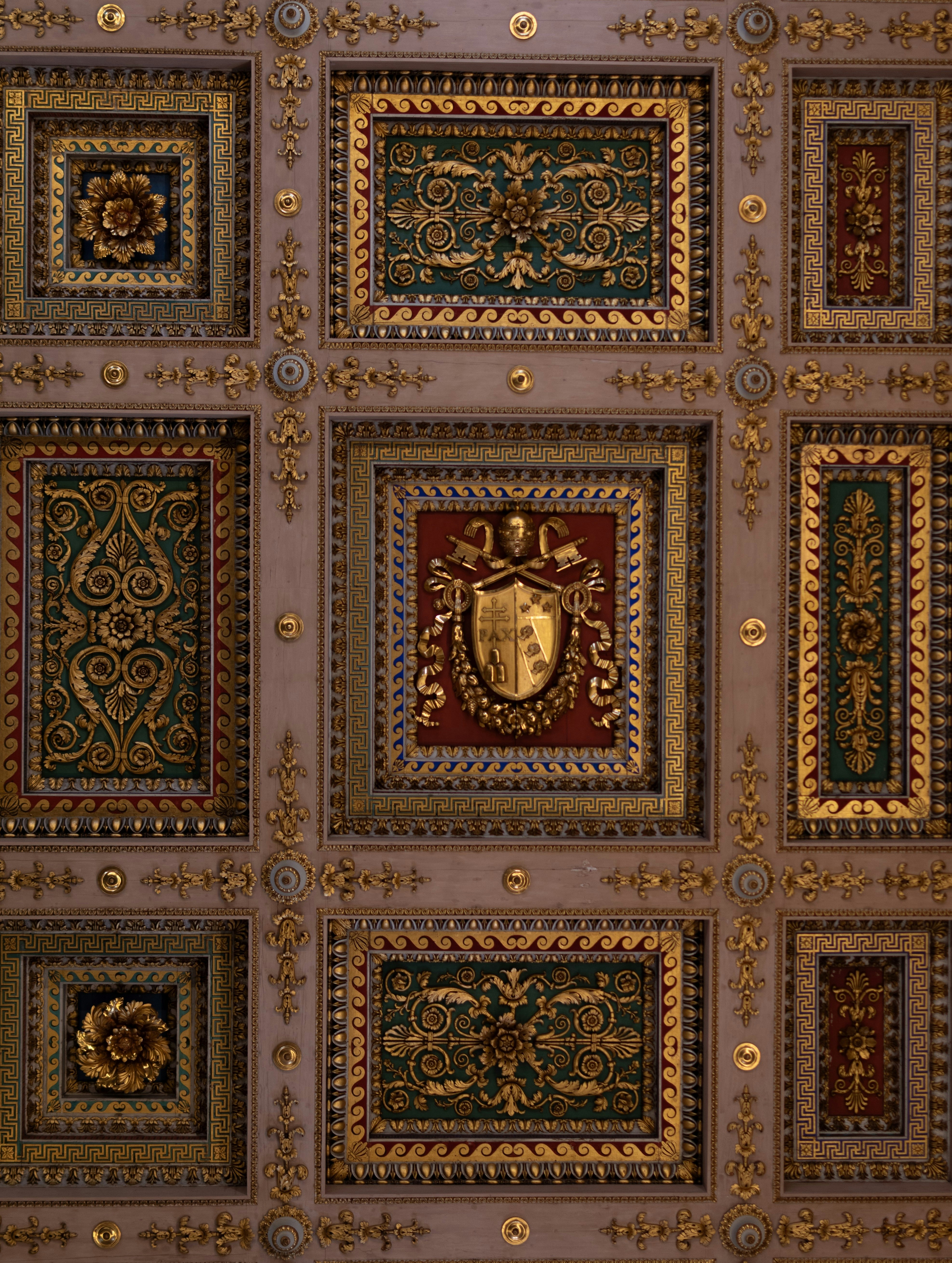 Ornate Ceiling Crest: A Hierarchy of Gold and Emerald Frames