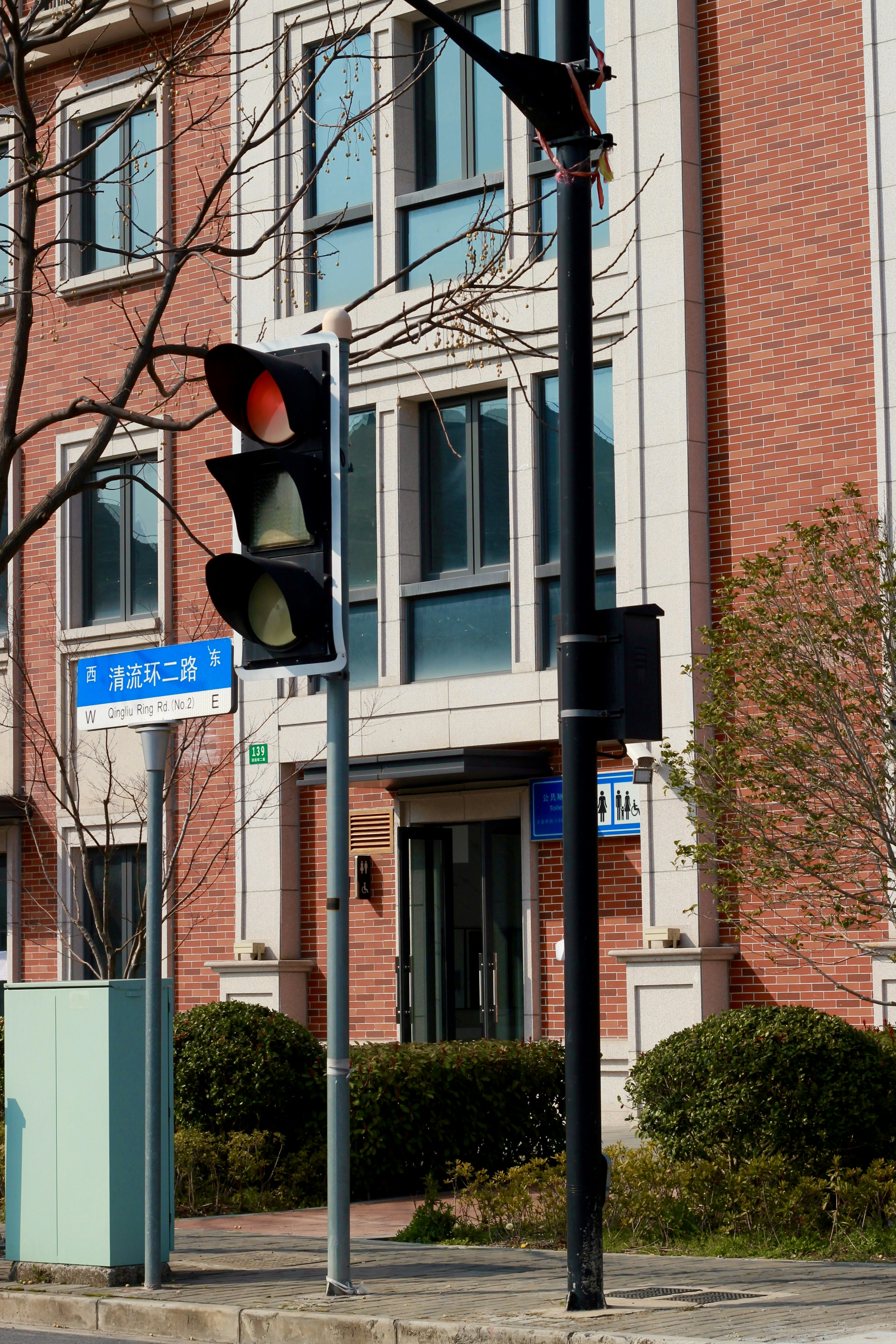 Urban Intersection: Red Brick Building Framed by Traffic Lights