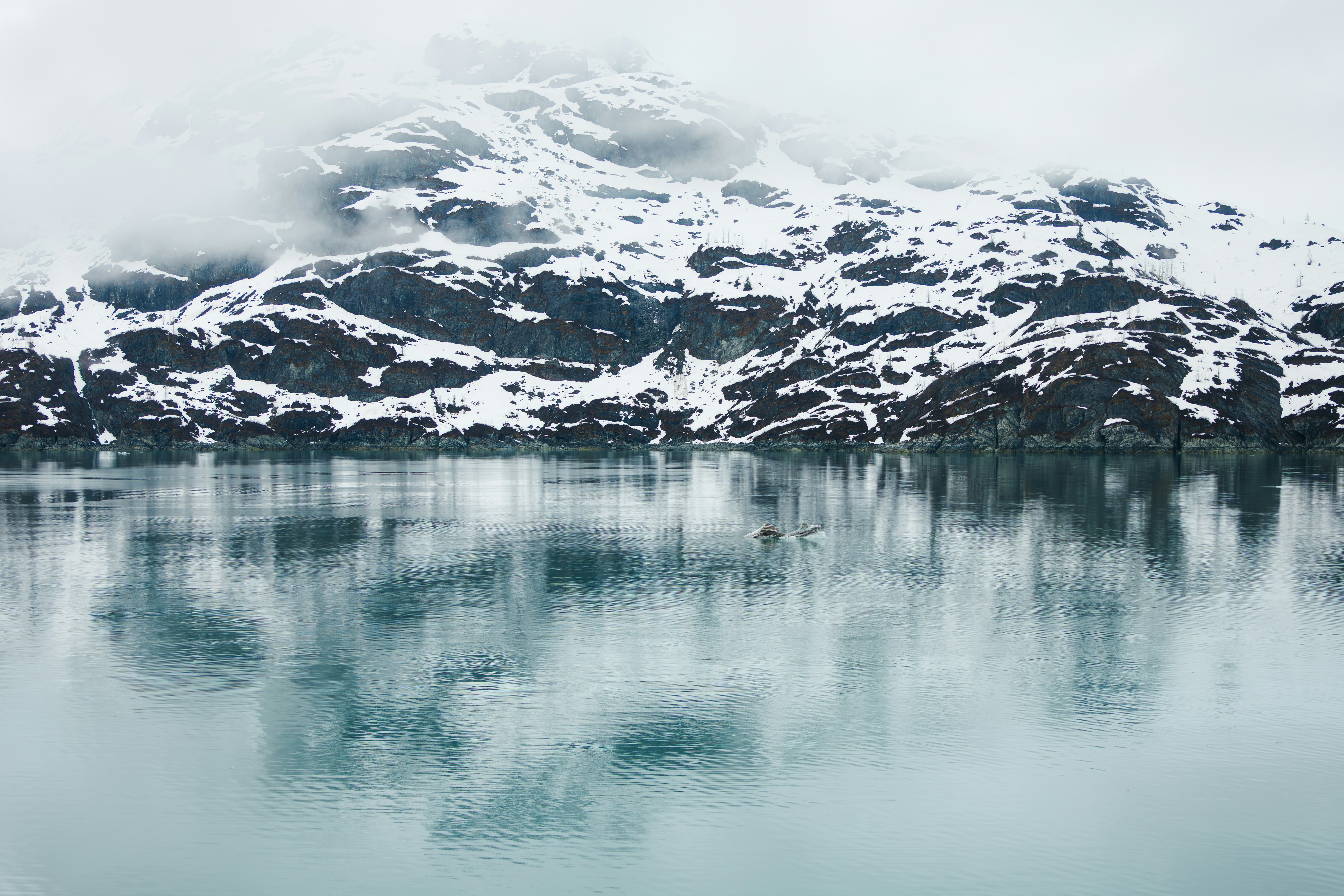 Glacial Quiet: Snow-dusted Peaks Mirror in Arctic Lake
