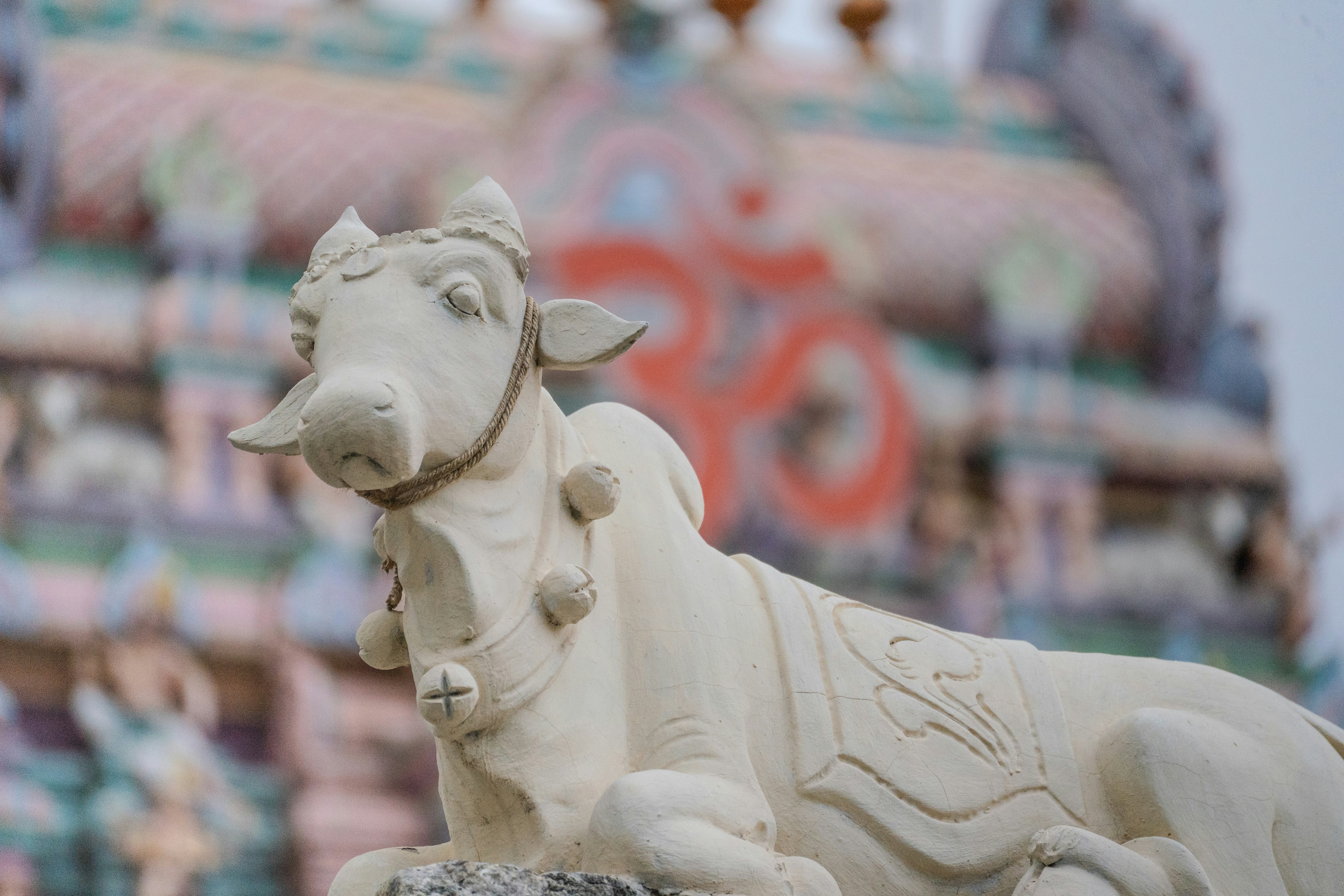 Stone Ox Guardian Beneath a Tapestry of Colorful Rooftops