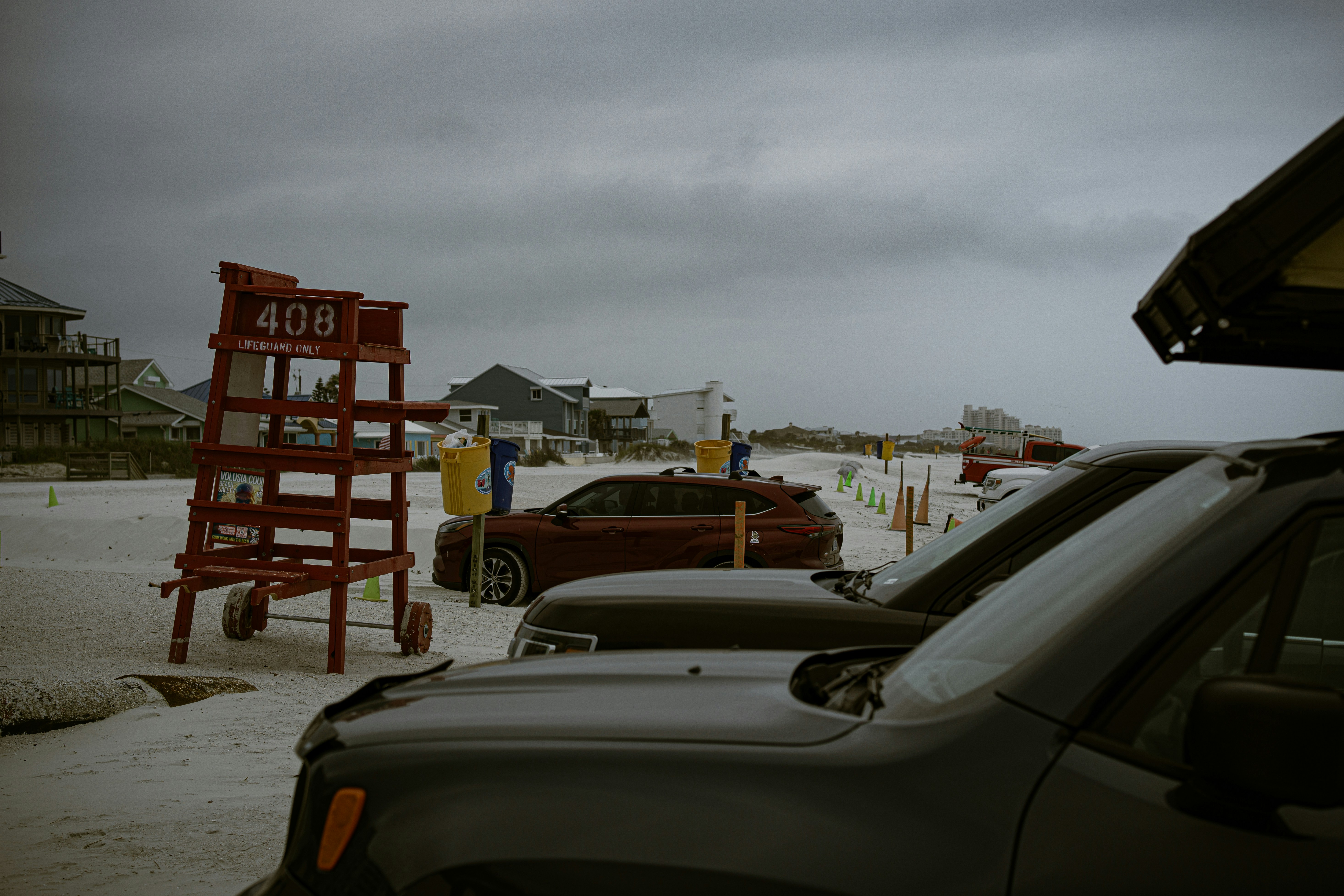 Coastline Parking: Red Lifeguard Chair and Row of Vehicles