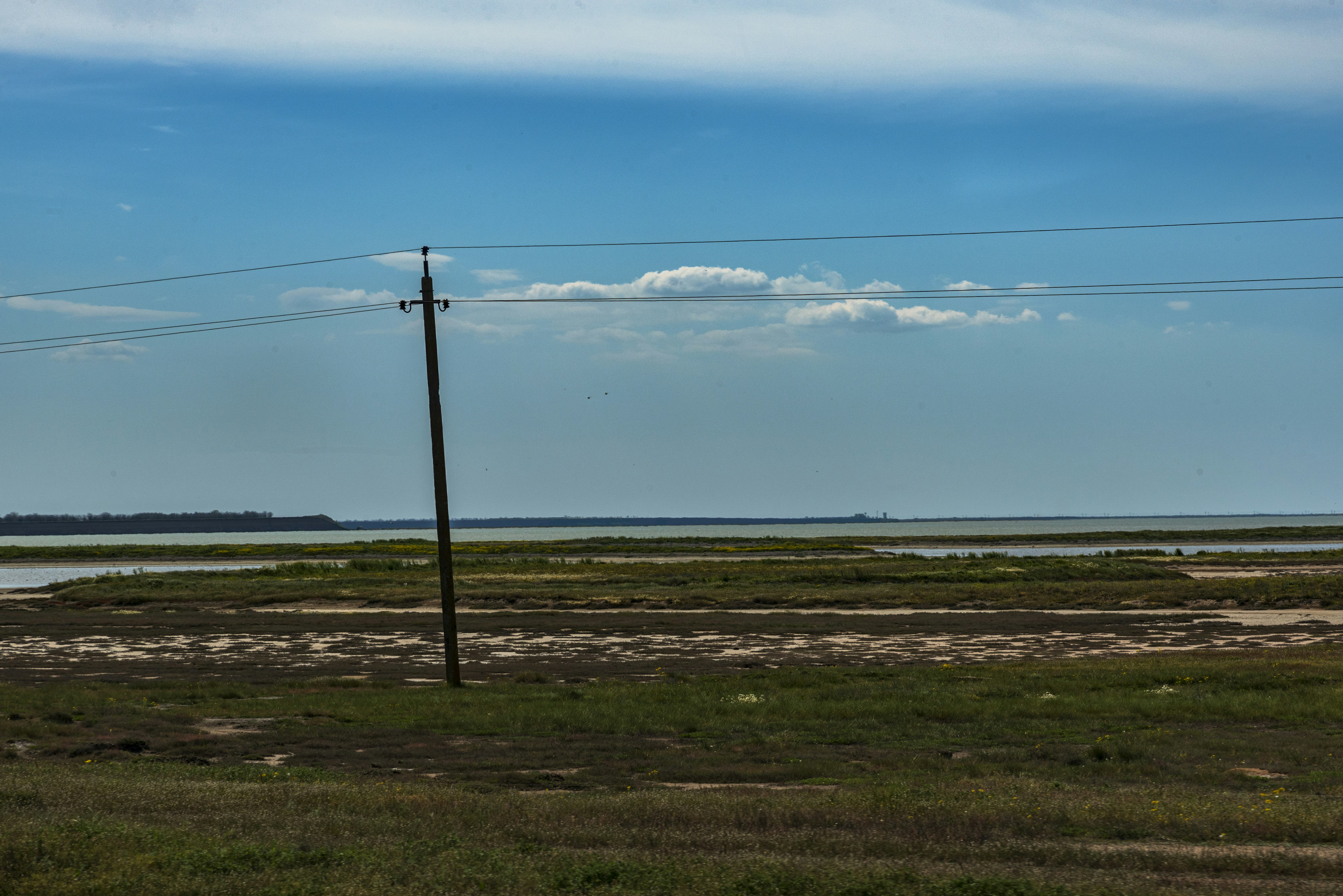Single Pole, Wide Horizon: Quiet Salt Flats under a Cerulean Sky