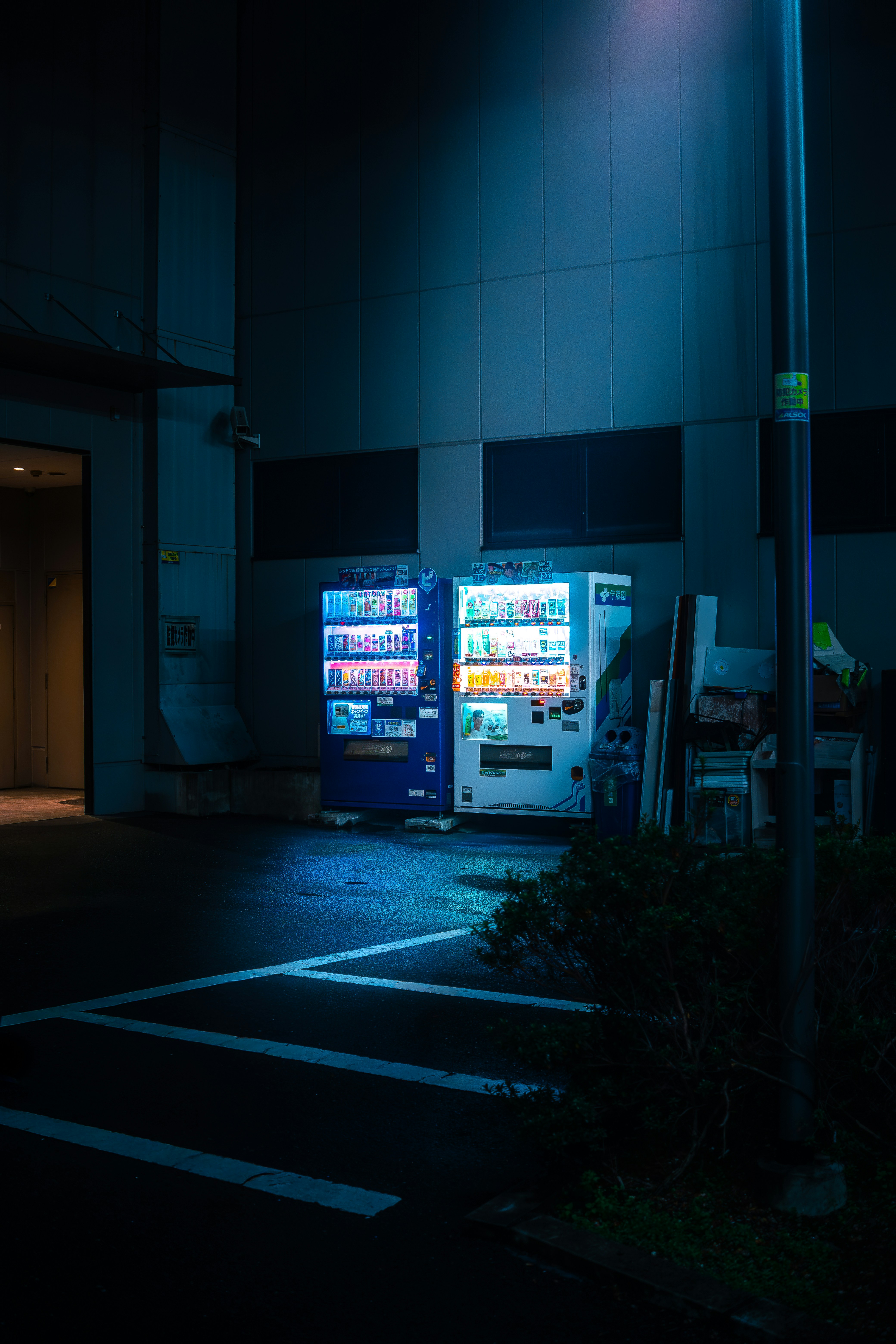 Neon Vending Duo Against a Quiet Building