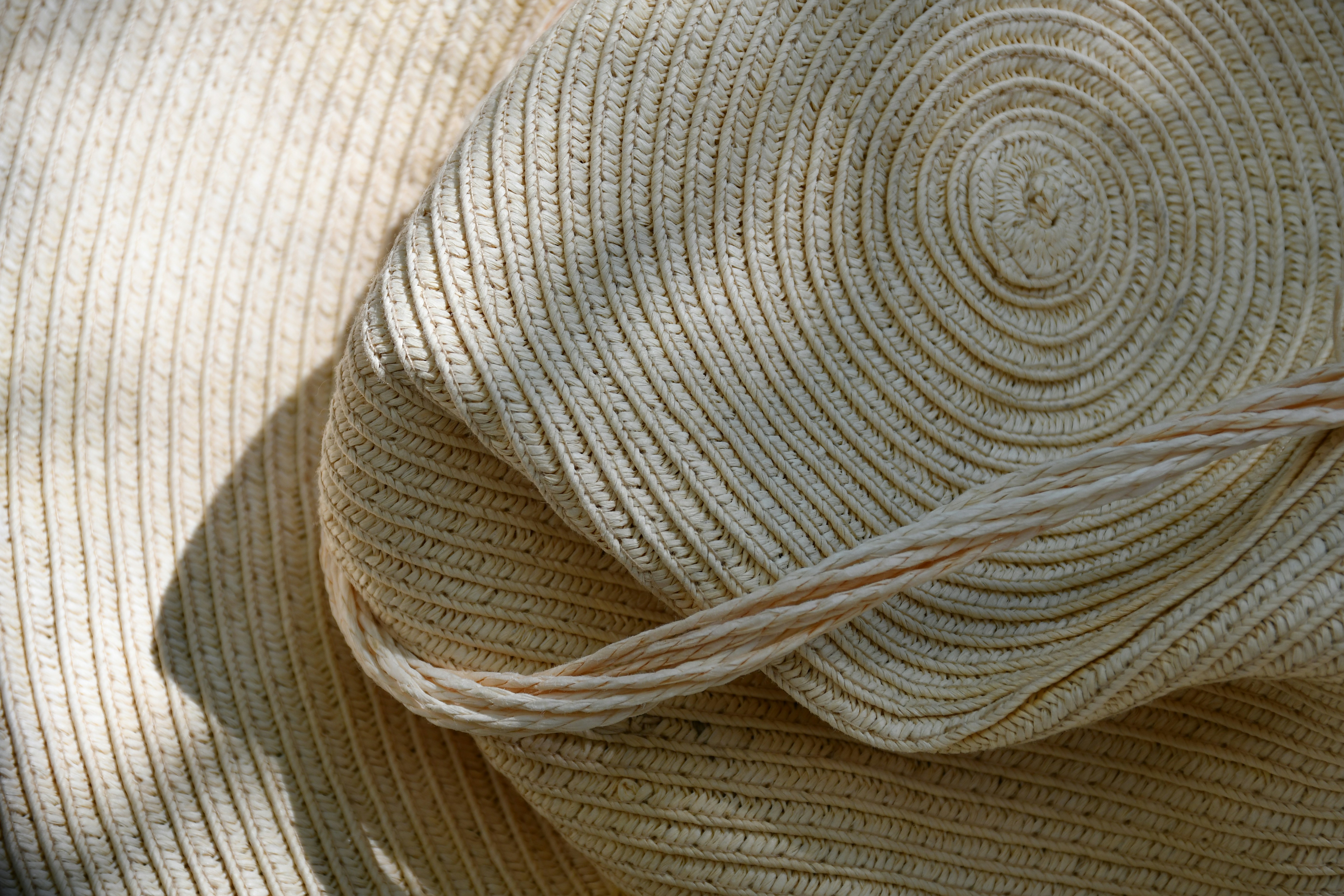 Rings of Sunlit Straw: A Close-Up of Concentric Weaves and Frayed Rope