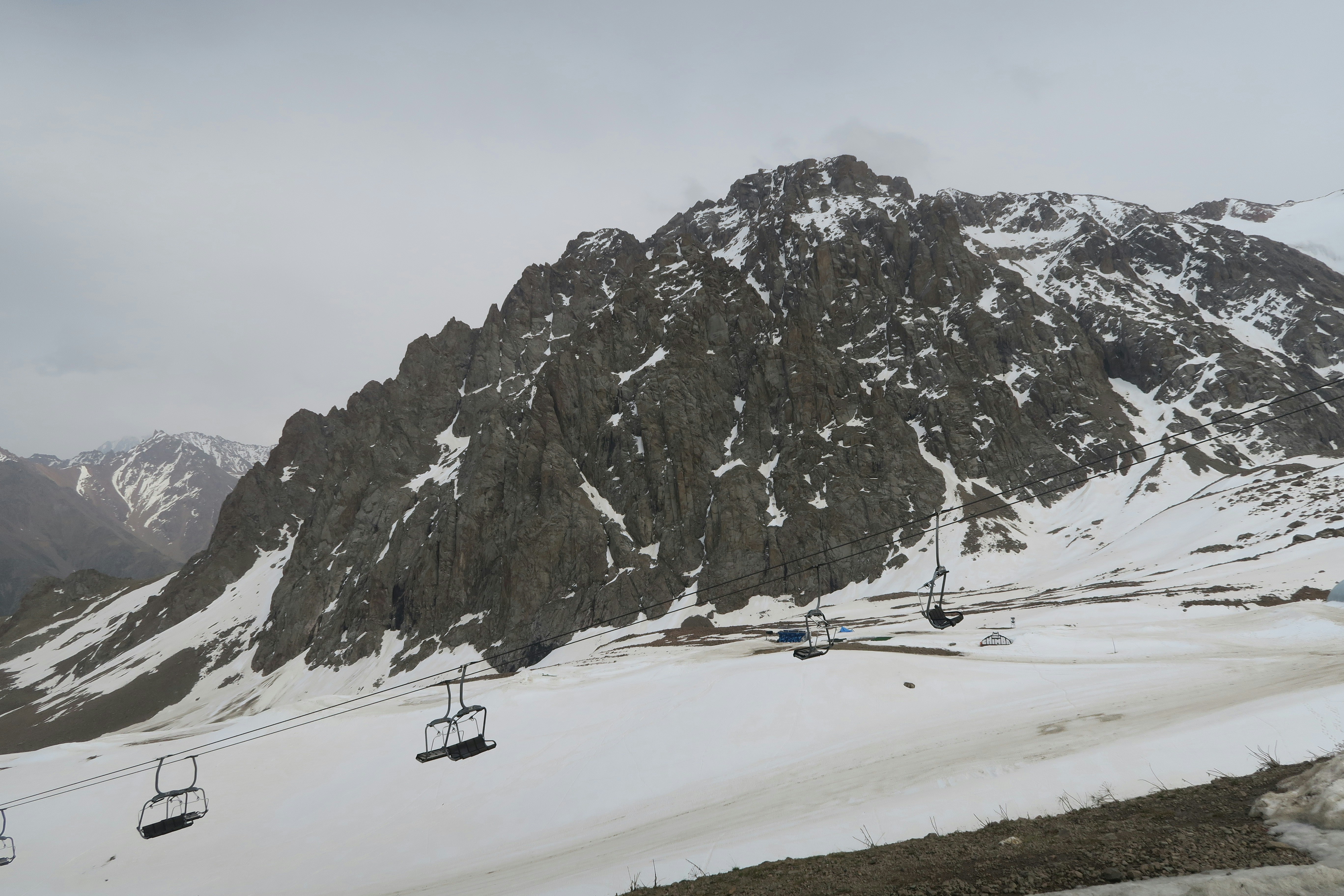 Snowy Slopes and Silent Lifts Beneath Jagged Peaks