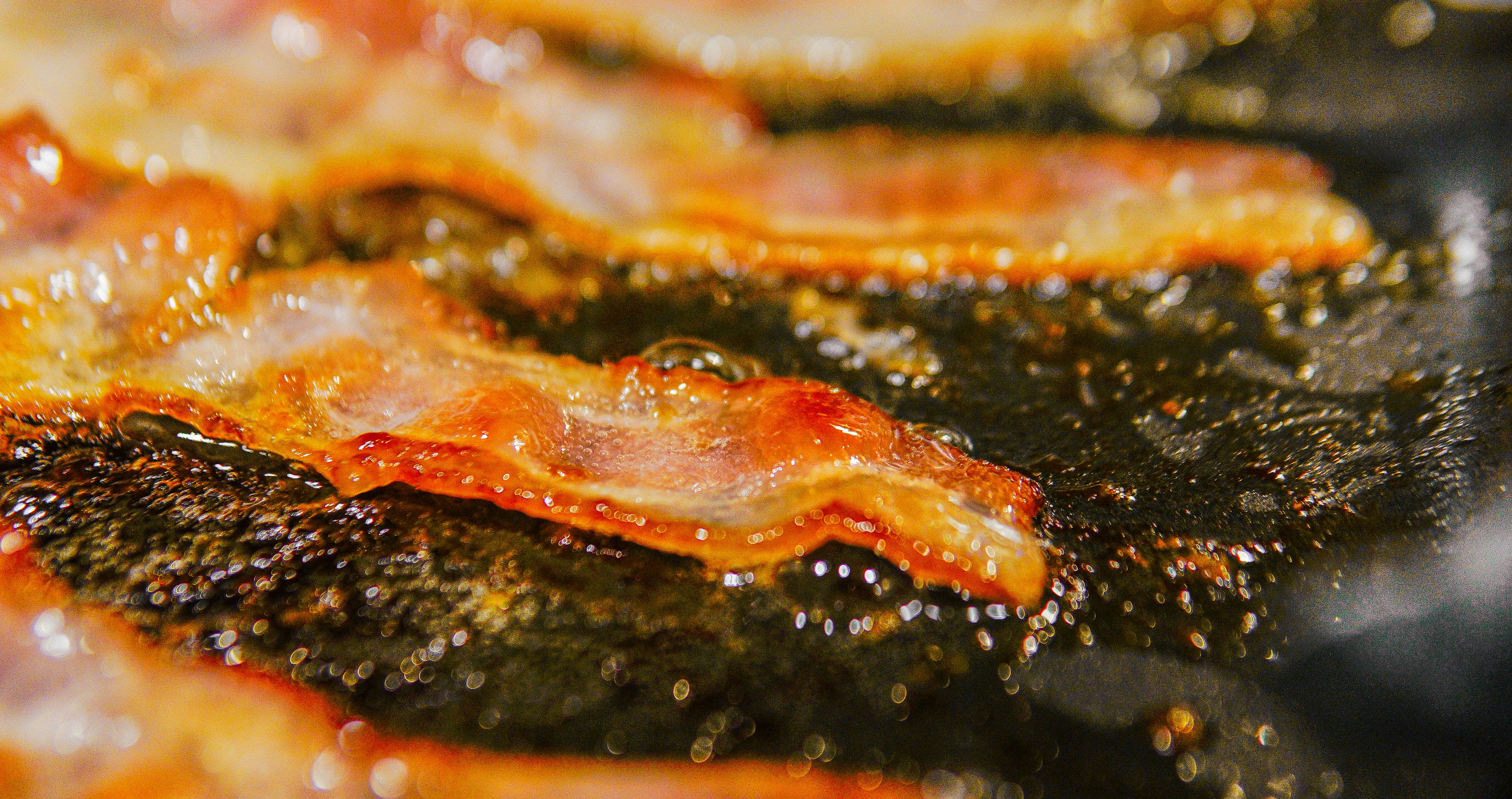 Crisp Bacon Ribbons Glistening on a Sizzling Pan