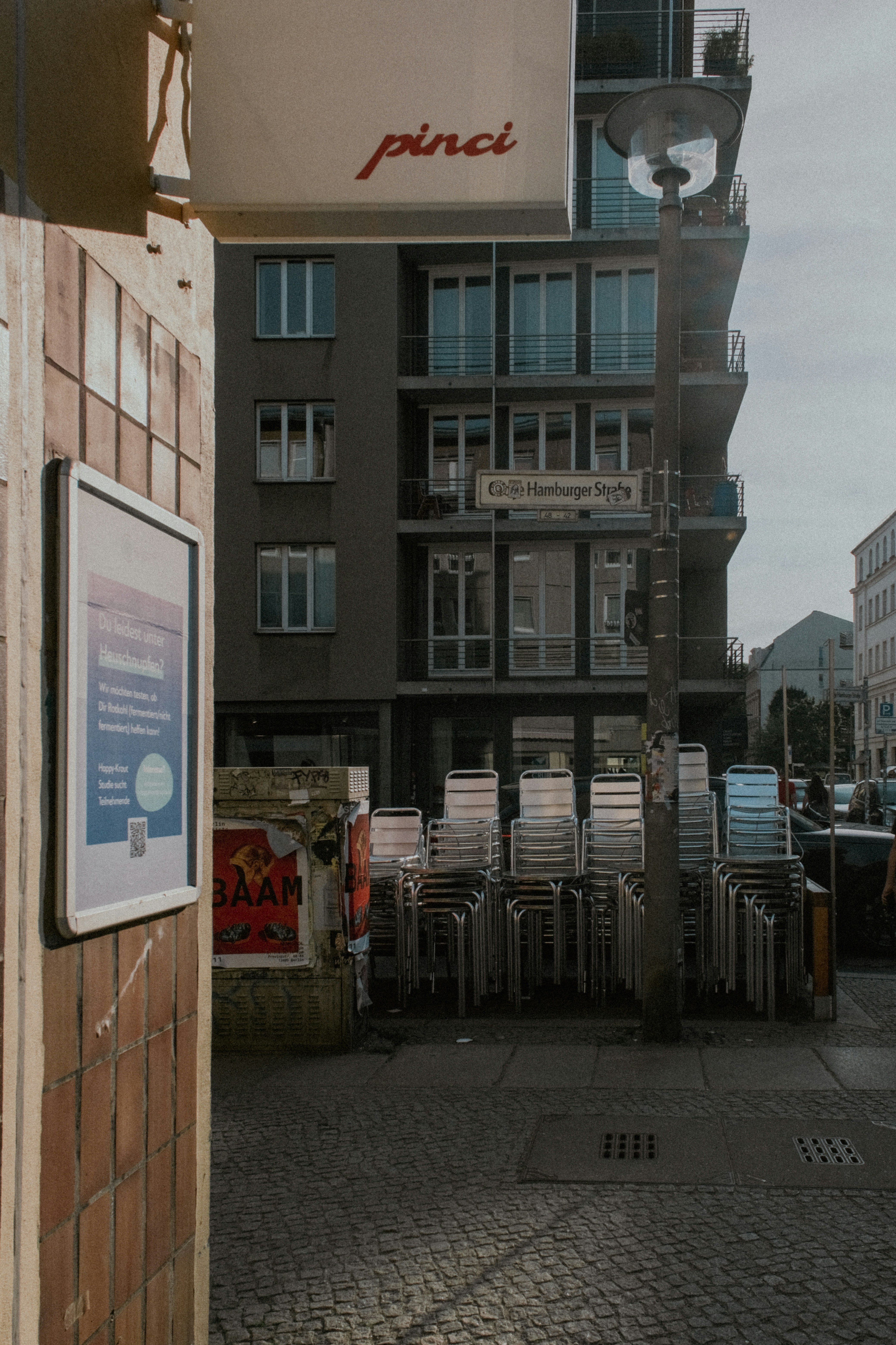 Stacked Chairs Behind Urban Facade