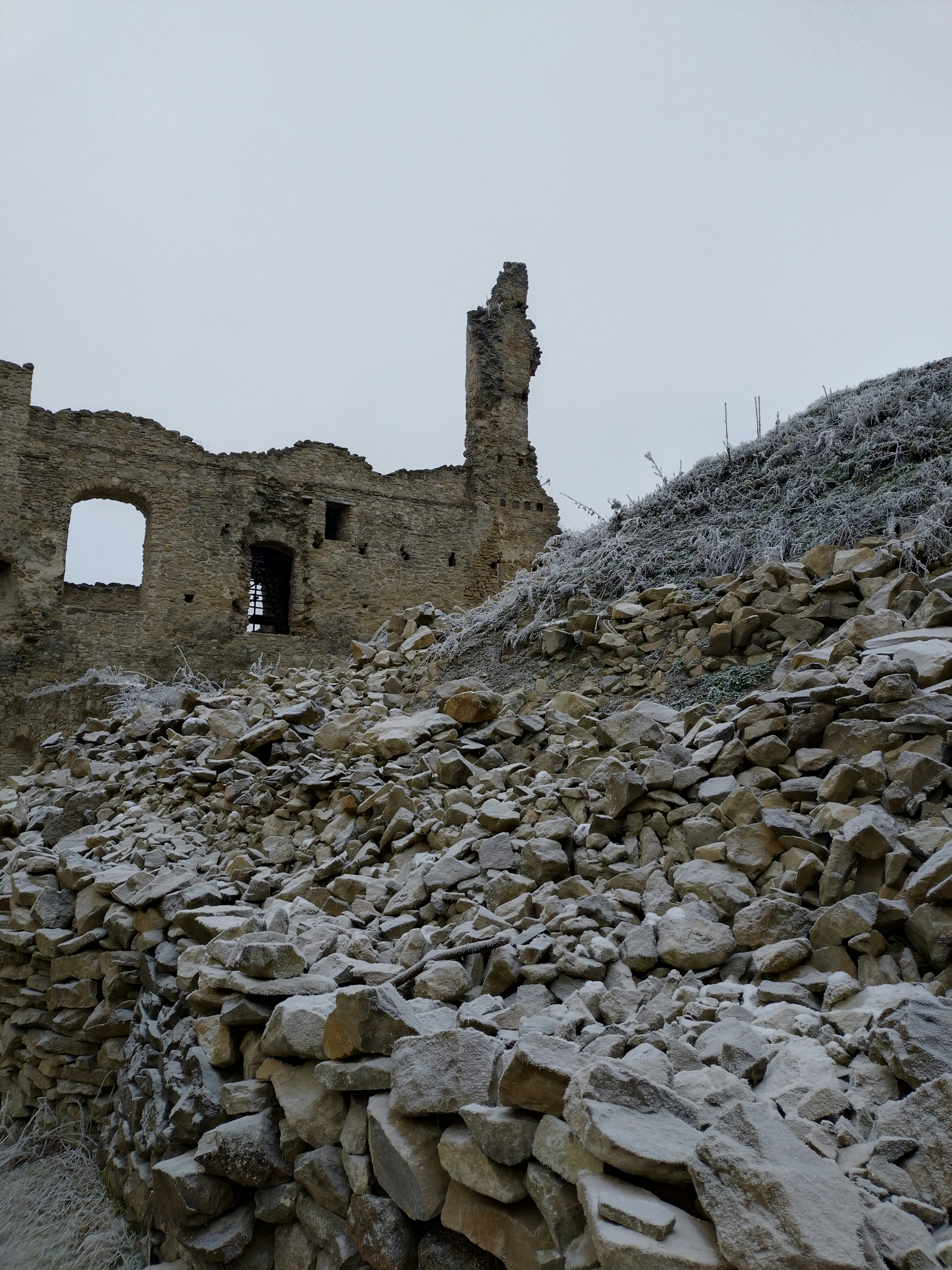 Ruins and Stone Ramparts Cling to a Frosted Slope