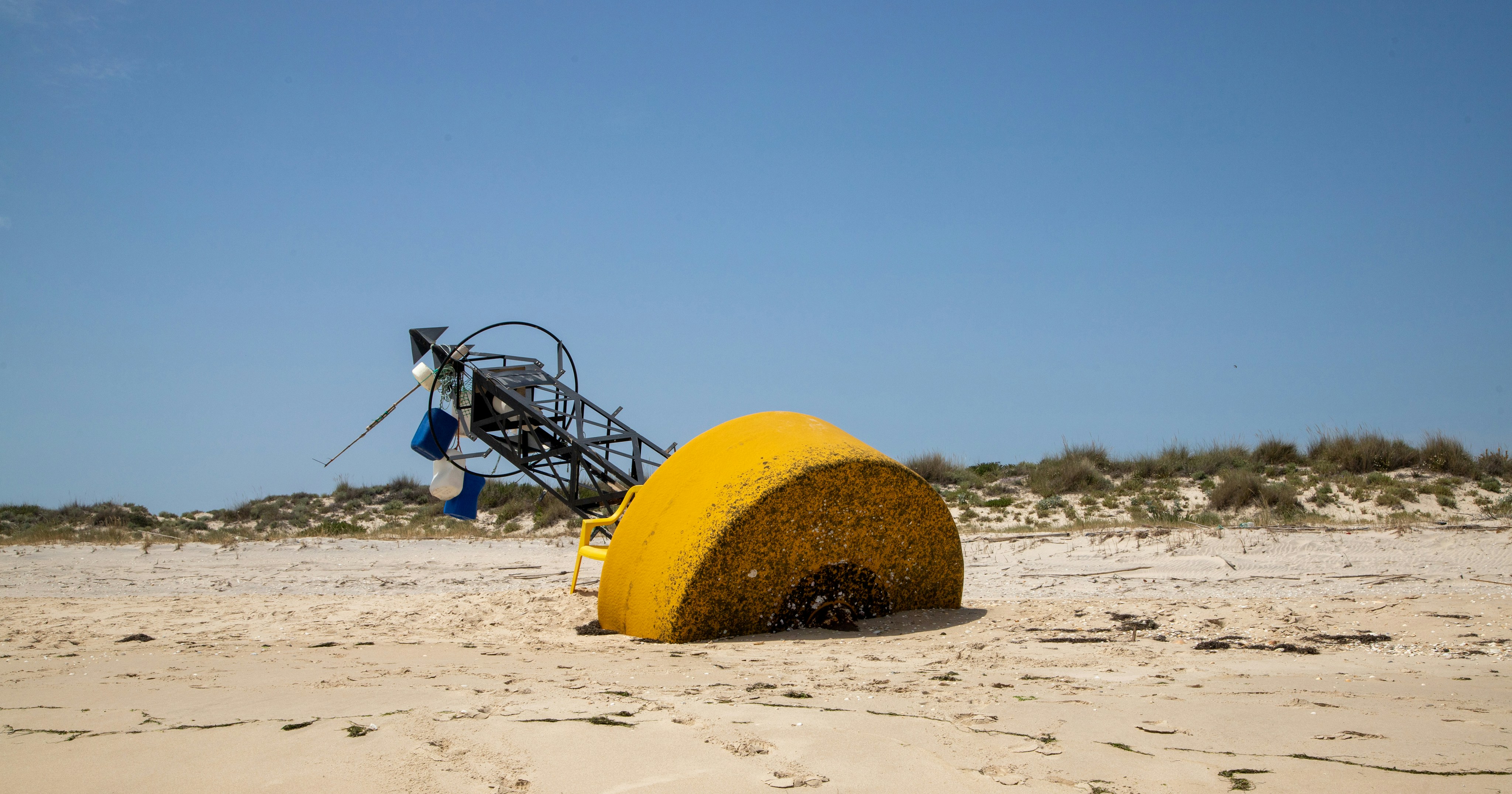 Yellow Half-Sphere on Quiet Shore: The remains of a seaside prop