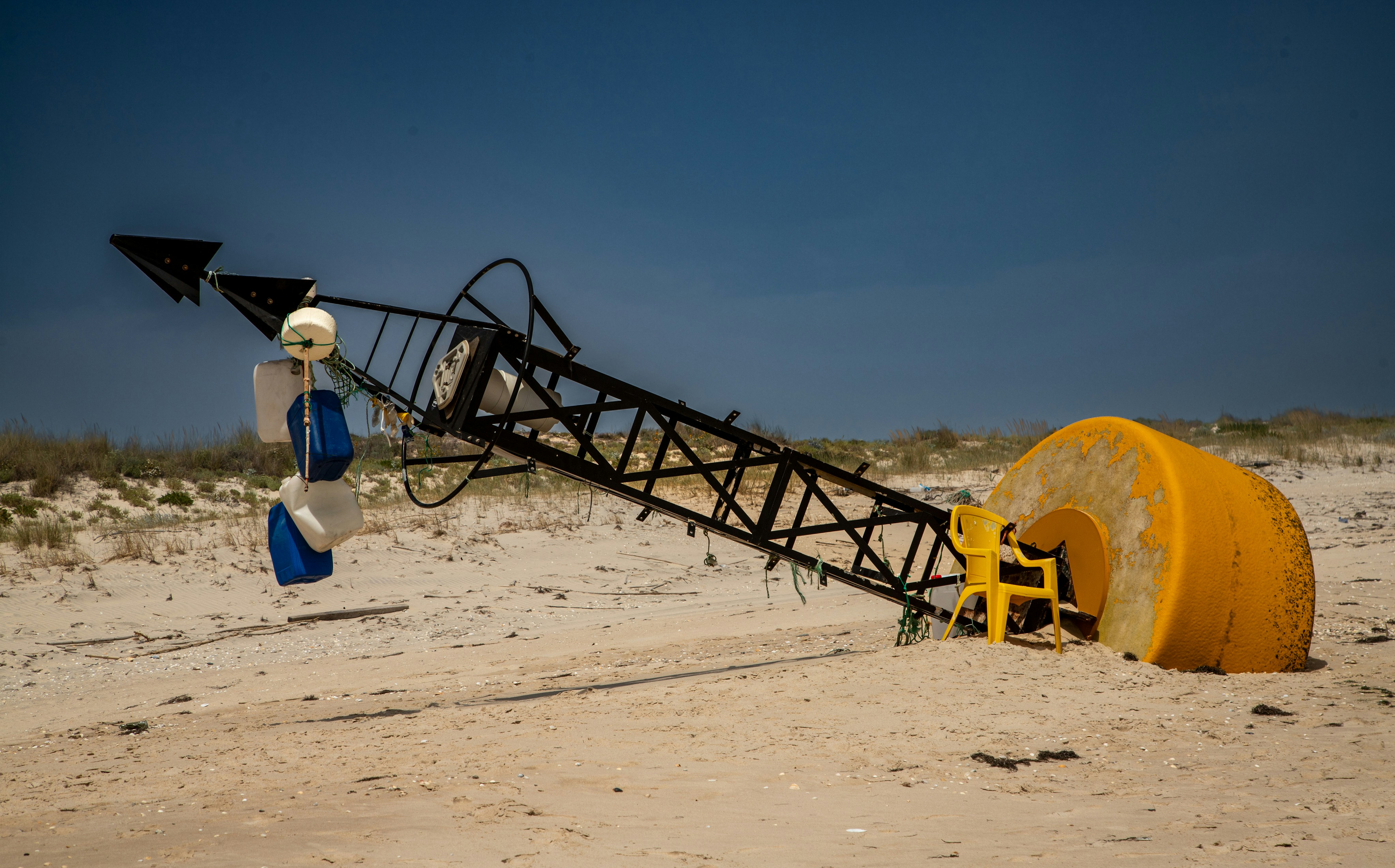 Desert Machinery Spooled: A Tilted Crane Resting in Dune Sands