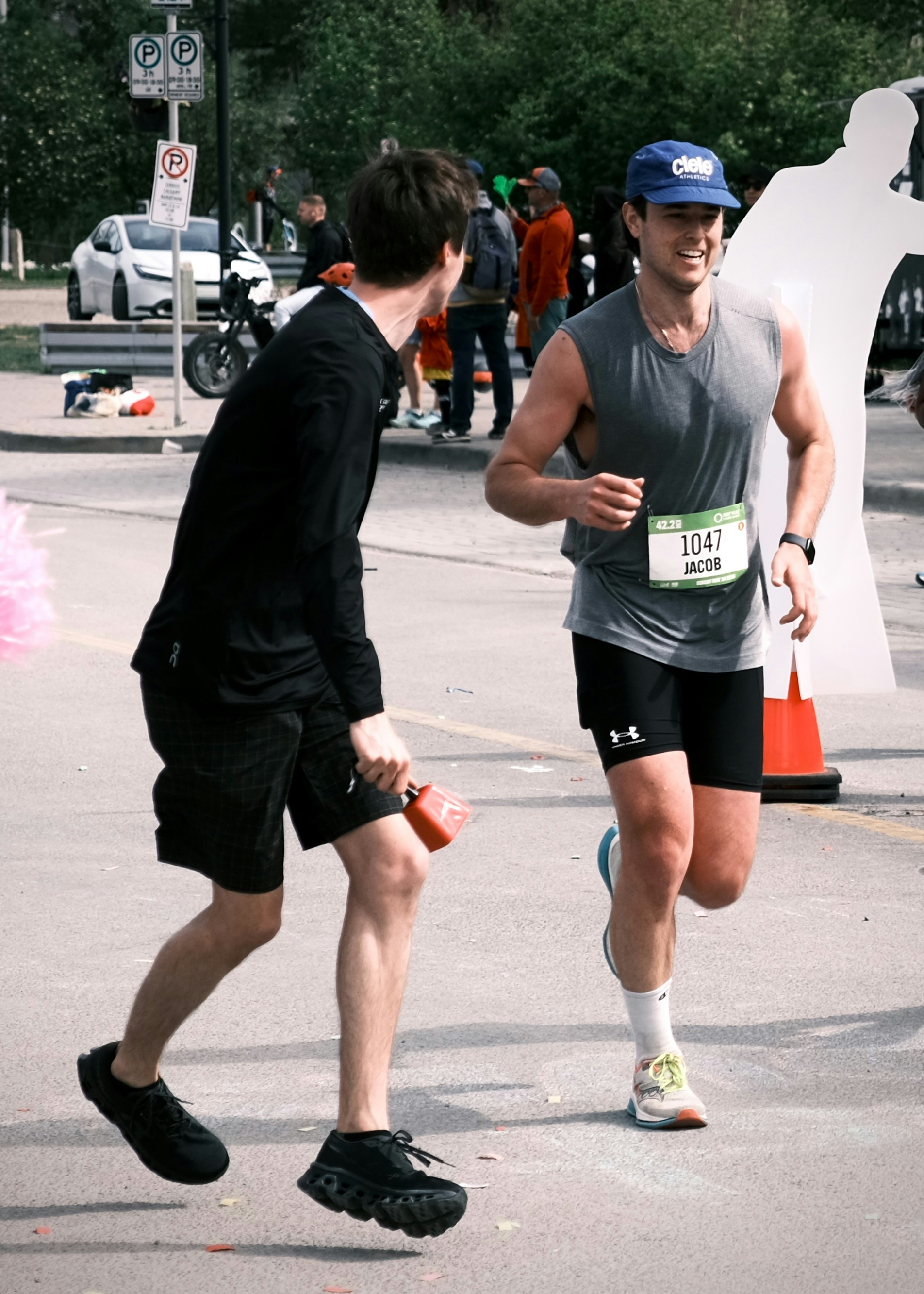 Runner in Gray Tank Top Reaches for the Finish as a Contender Chats Nearby