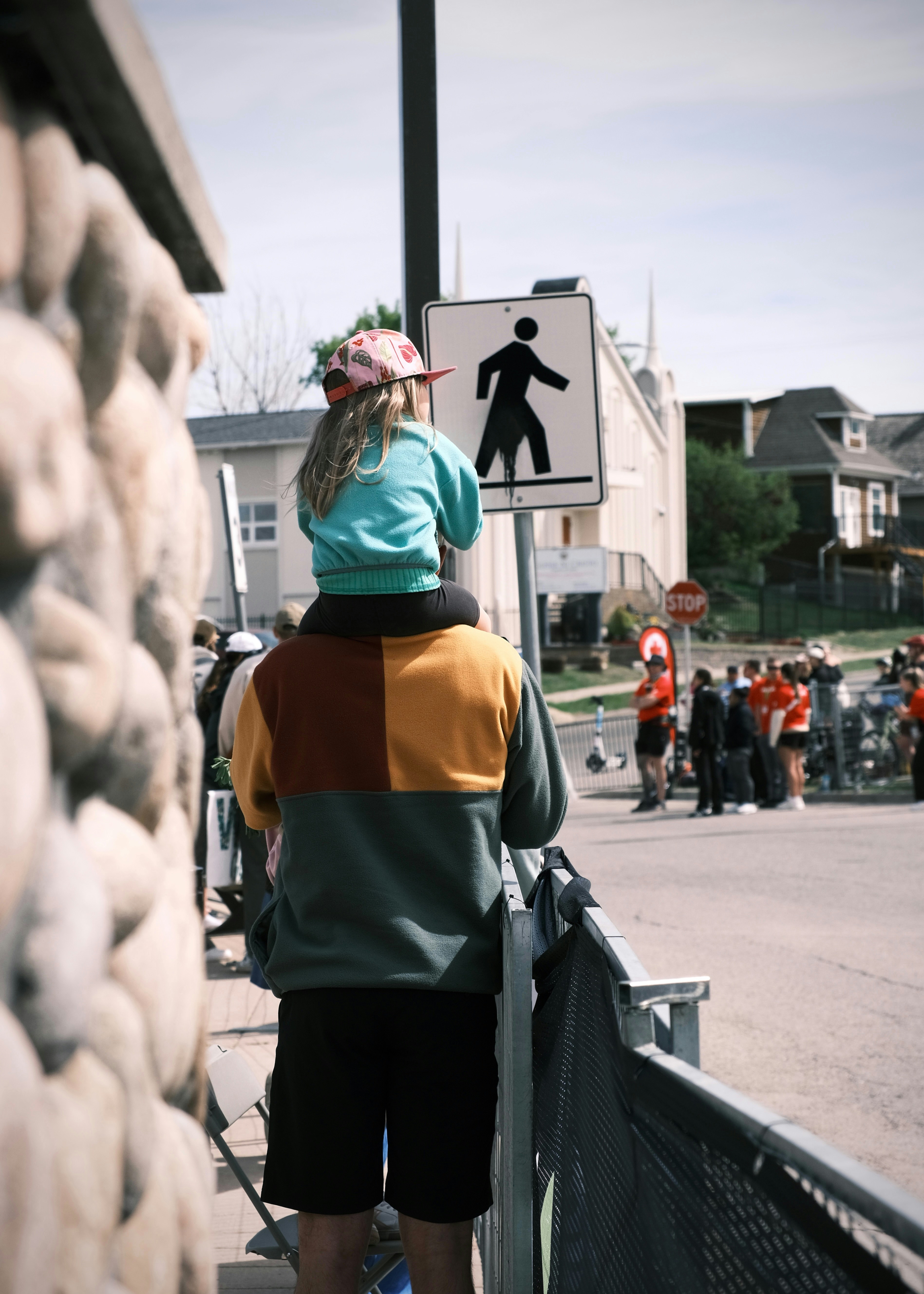 Child on Shoulders Overlook the Street Crossing