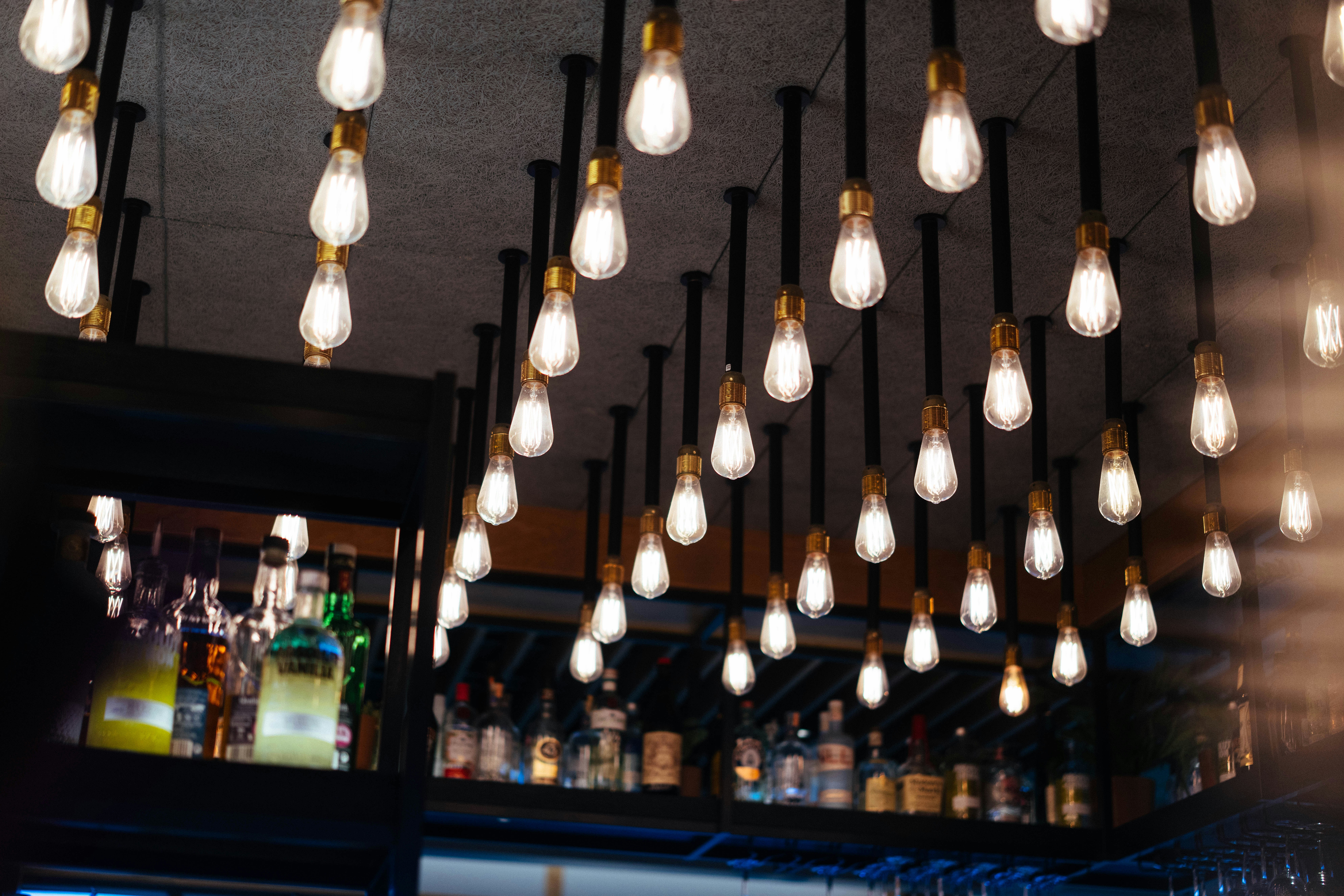Ambient Orchard of Light: A Ceiling of Edison Bulbs over a Backlit Bar