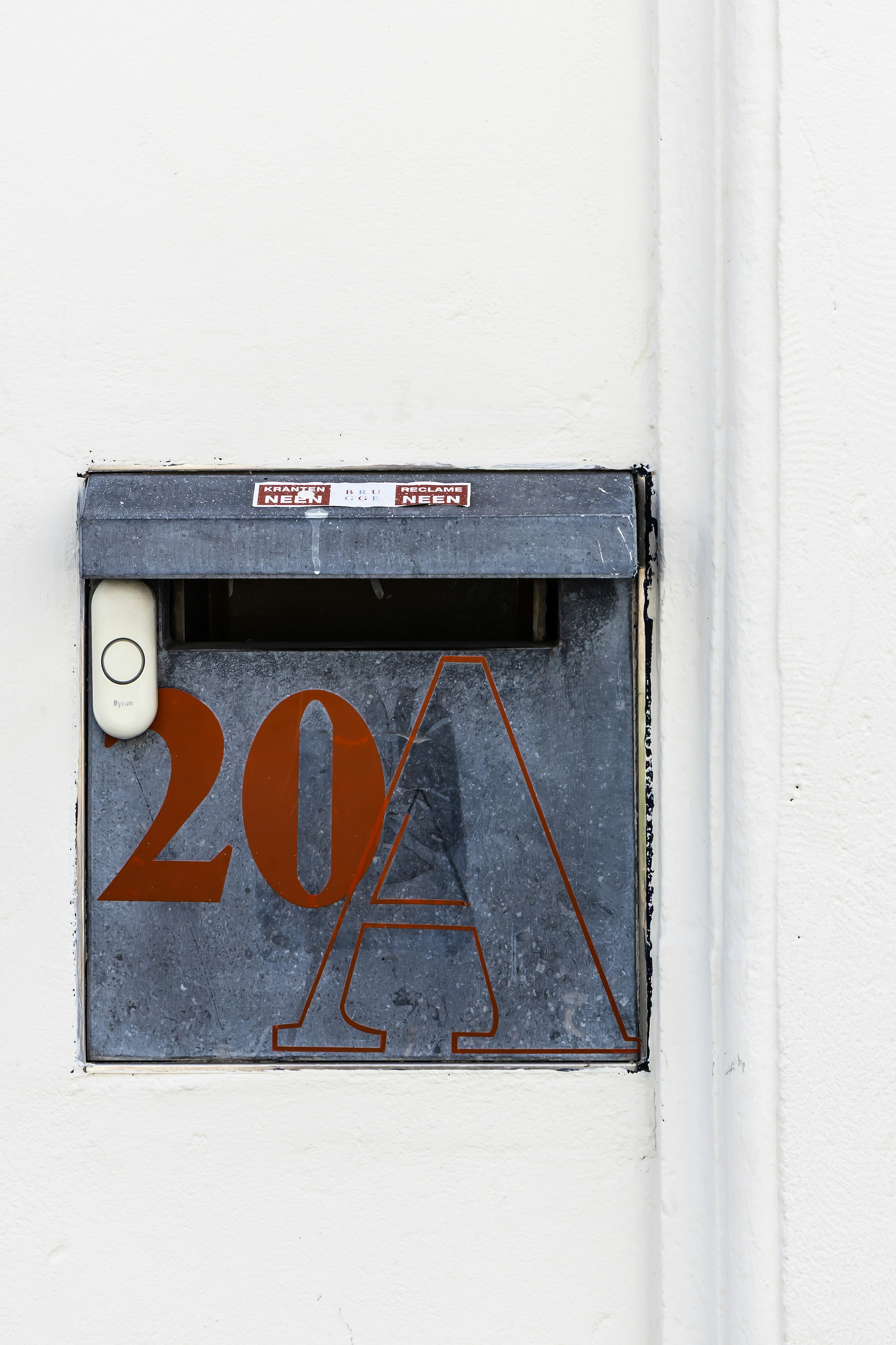 Postal Slot at the Edge of a Weathered Door