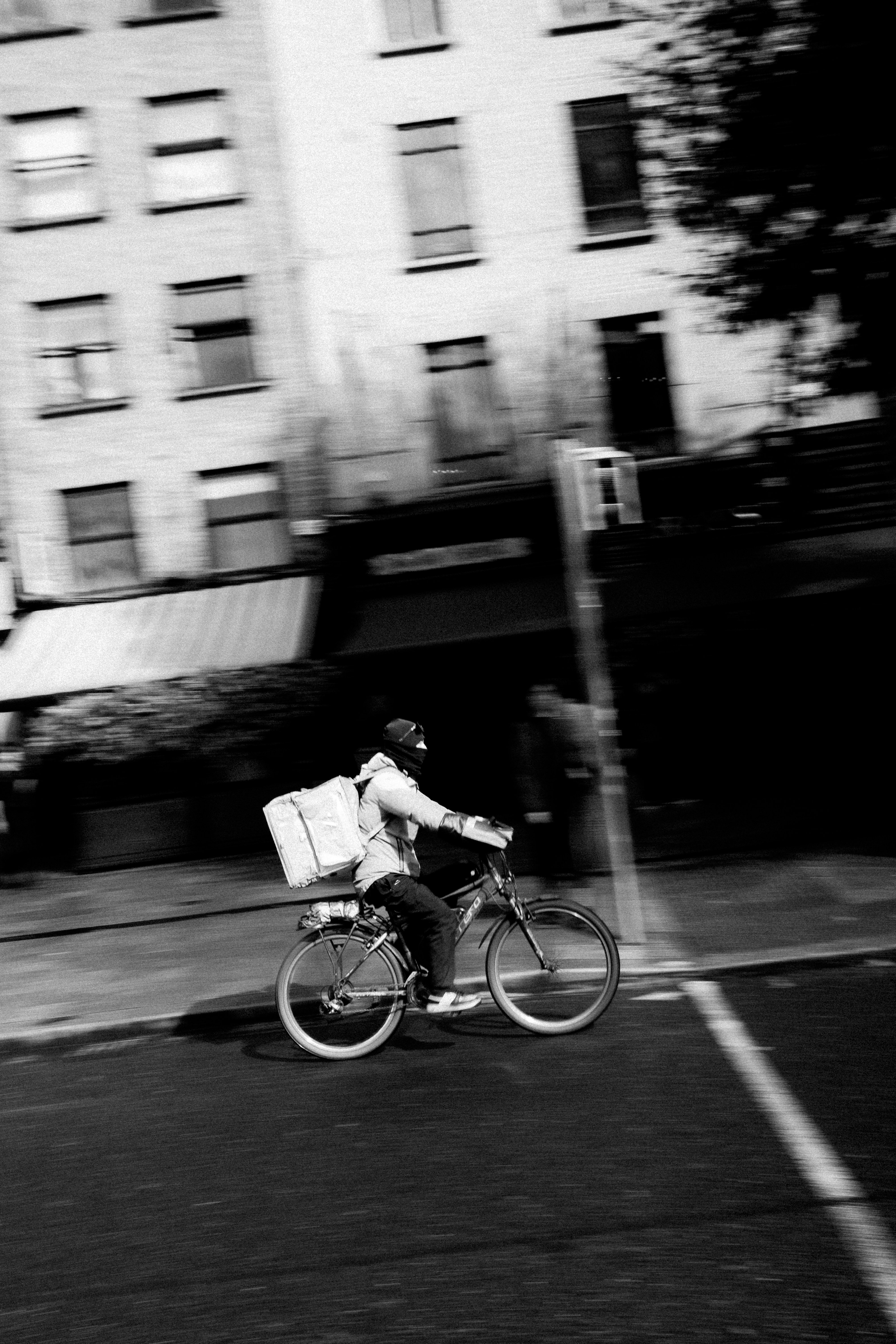 Courier on the Move: A Black-and-White City Glide