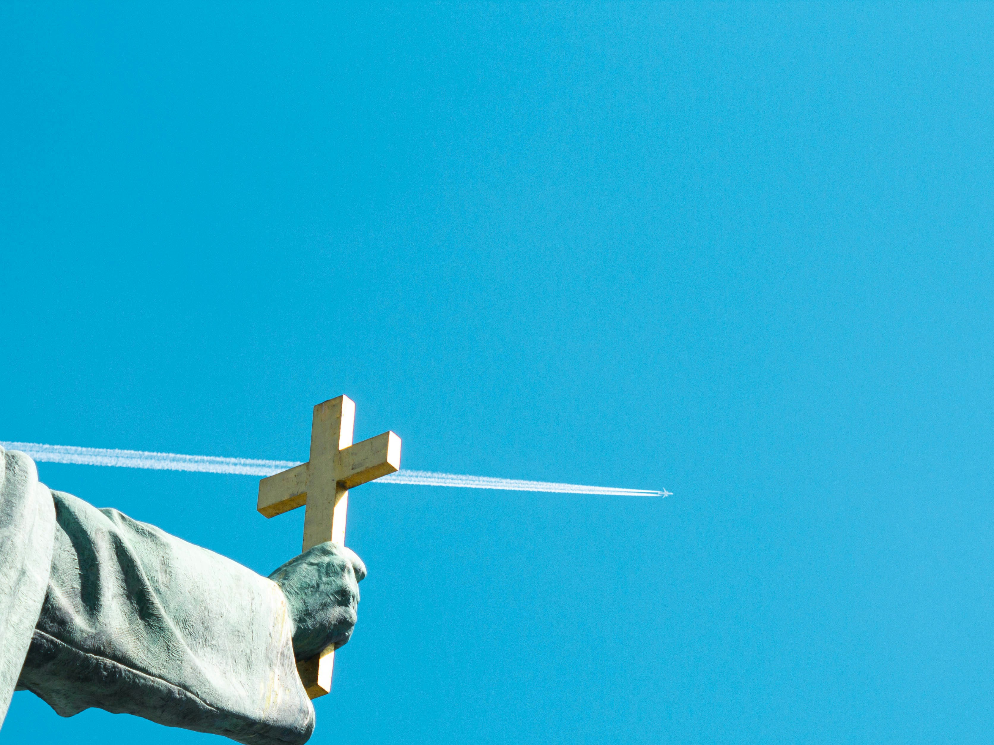Silver Cross in Blue Sky: A Moment of Quiet Reverence