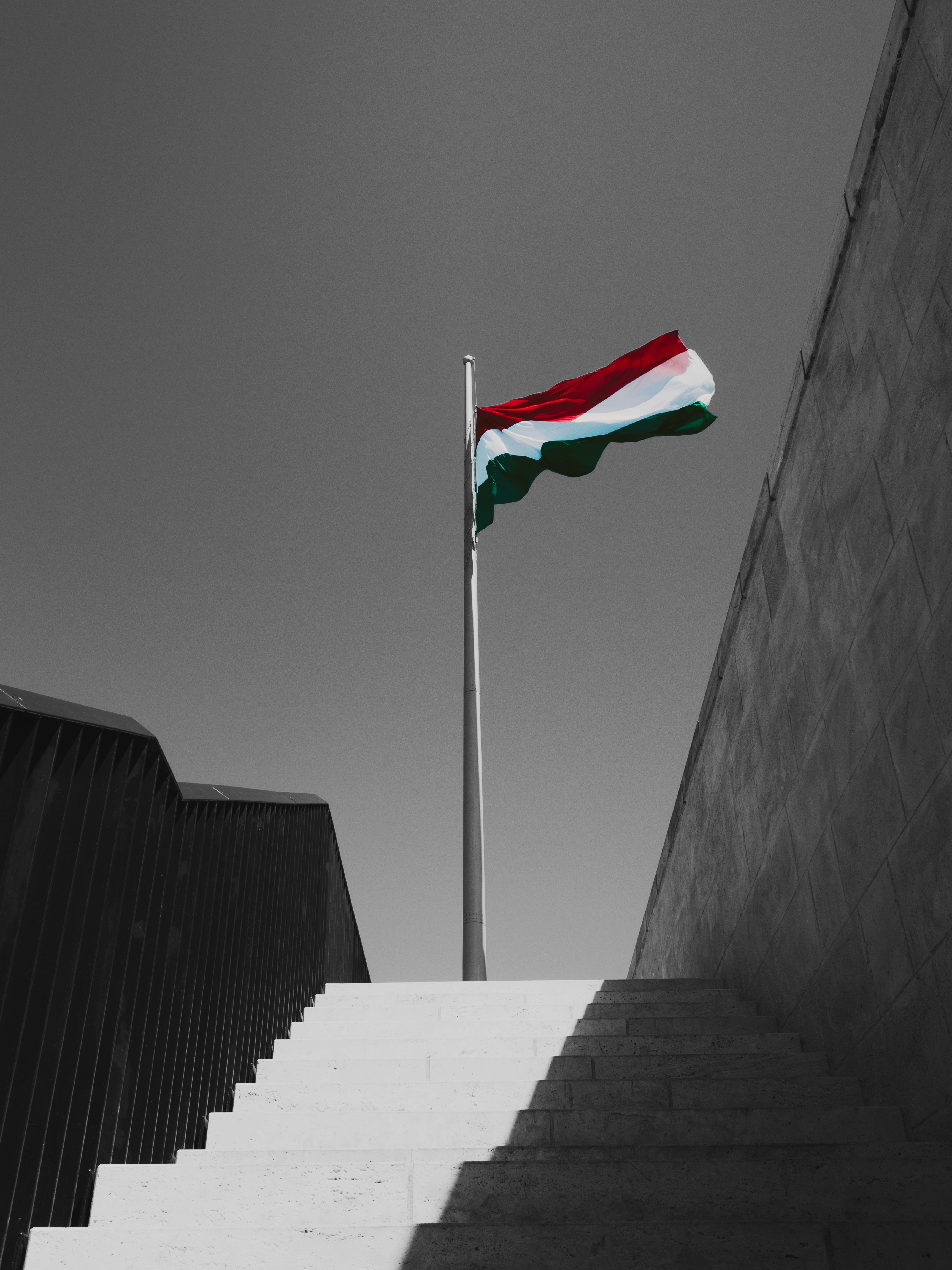 Flag on the Staircase: A Nation’s Emblem Rising Above Concrete