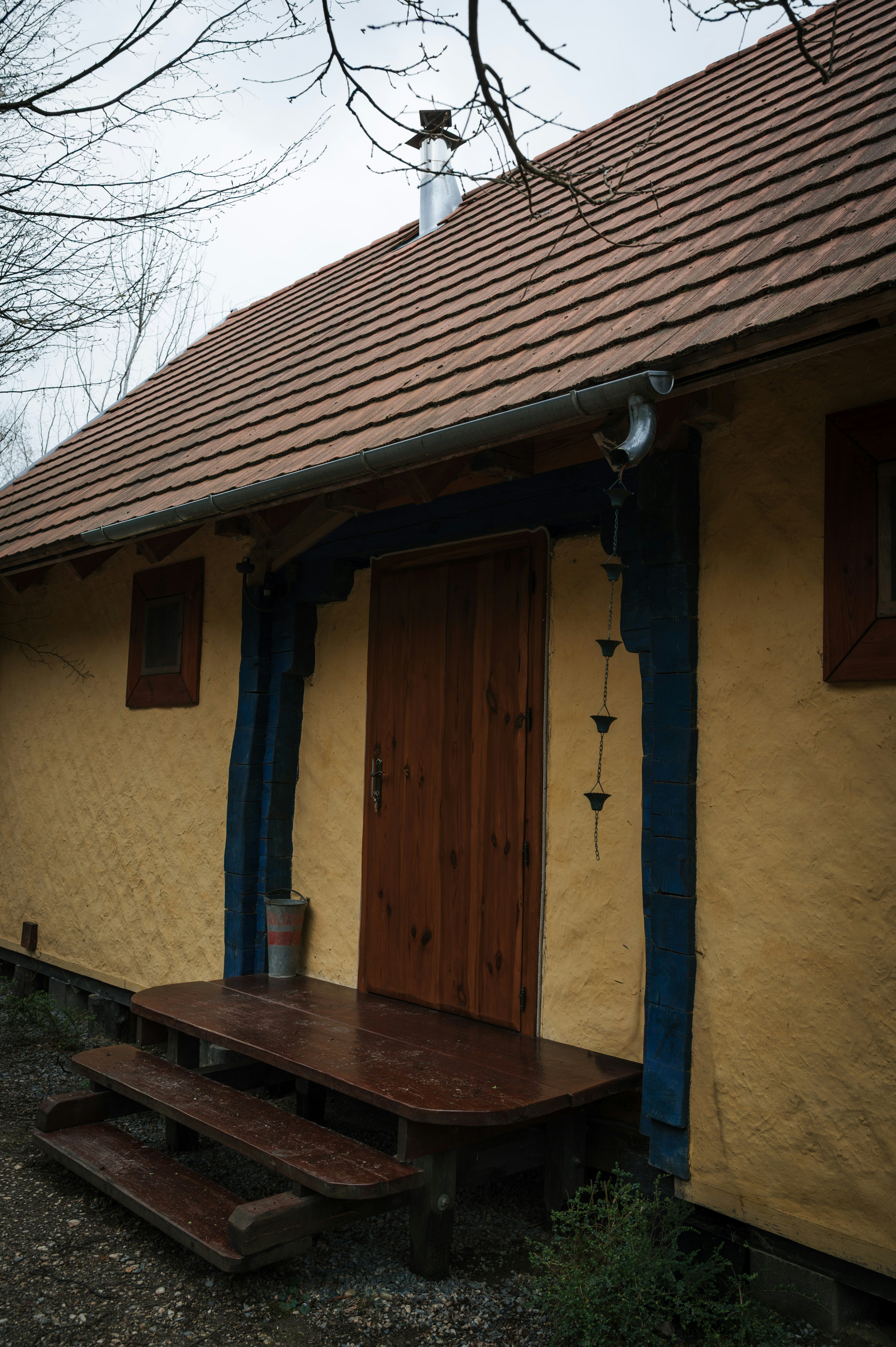 Weathered Cottage Doorway: A Quiet Step into Stucco and Timber