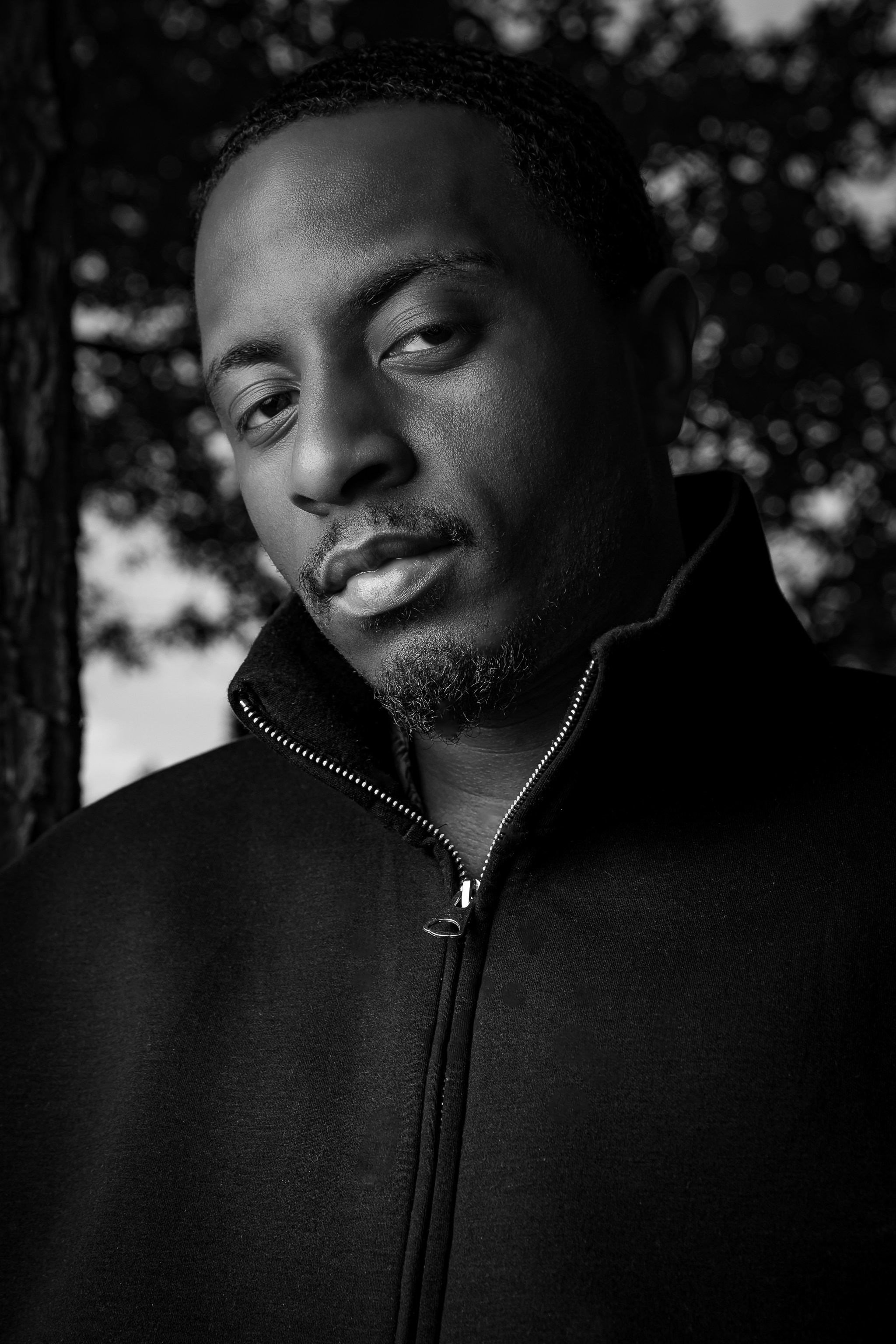 Quiet Confidence: A Black-and-White Portrait in Shadowed Light