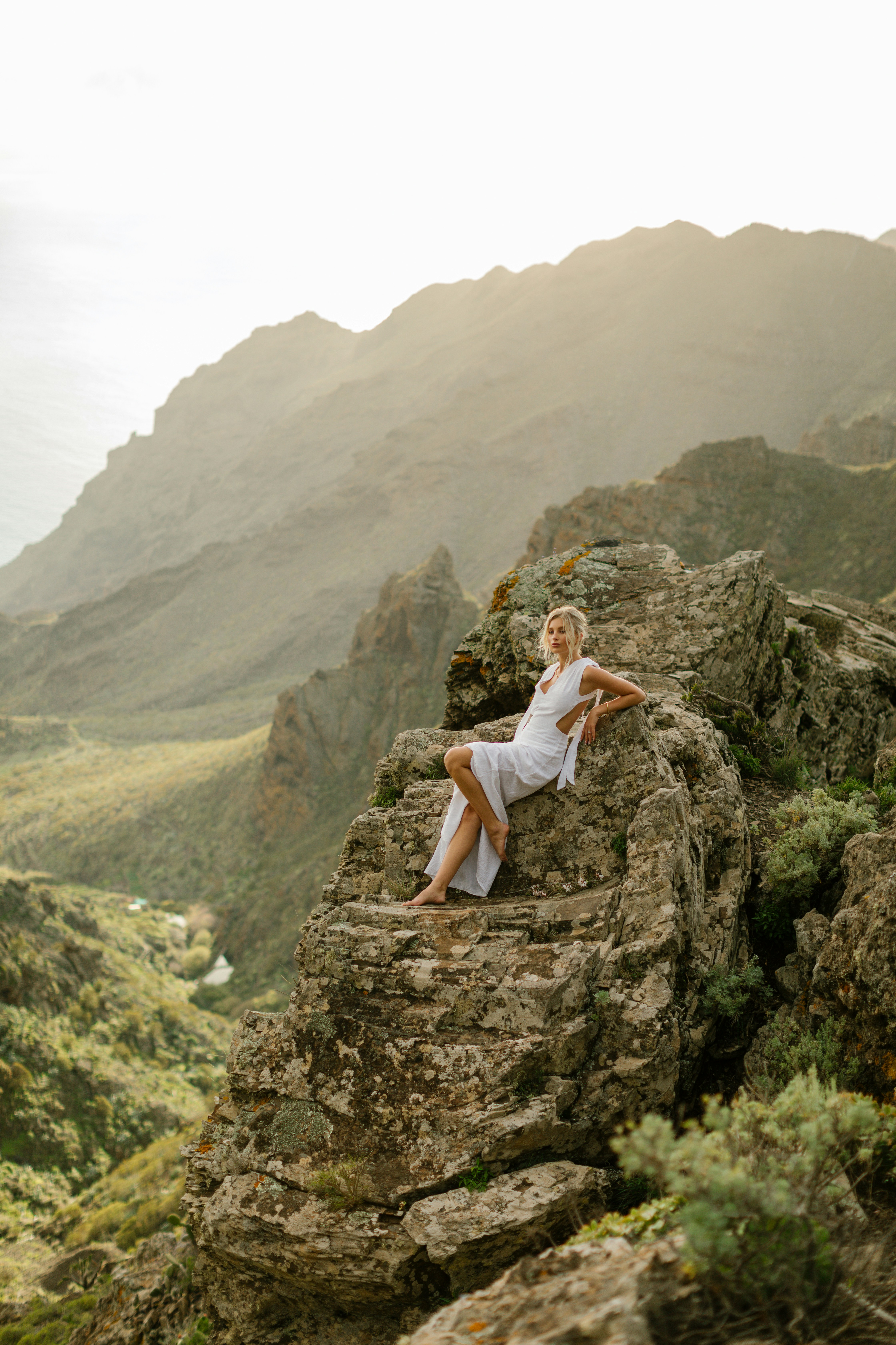 Cliffside Quiet: A Woman in White Beside the Canyon