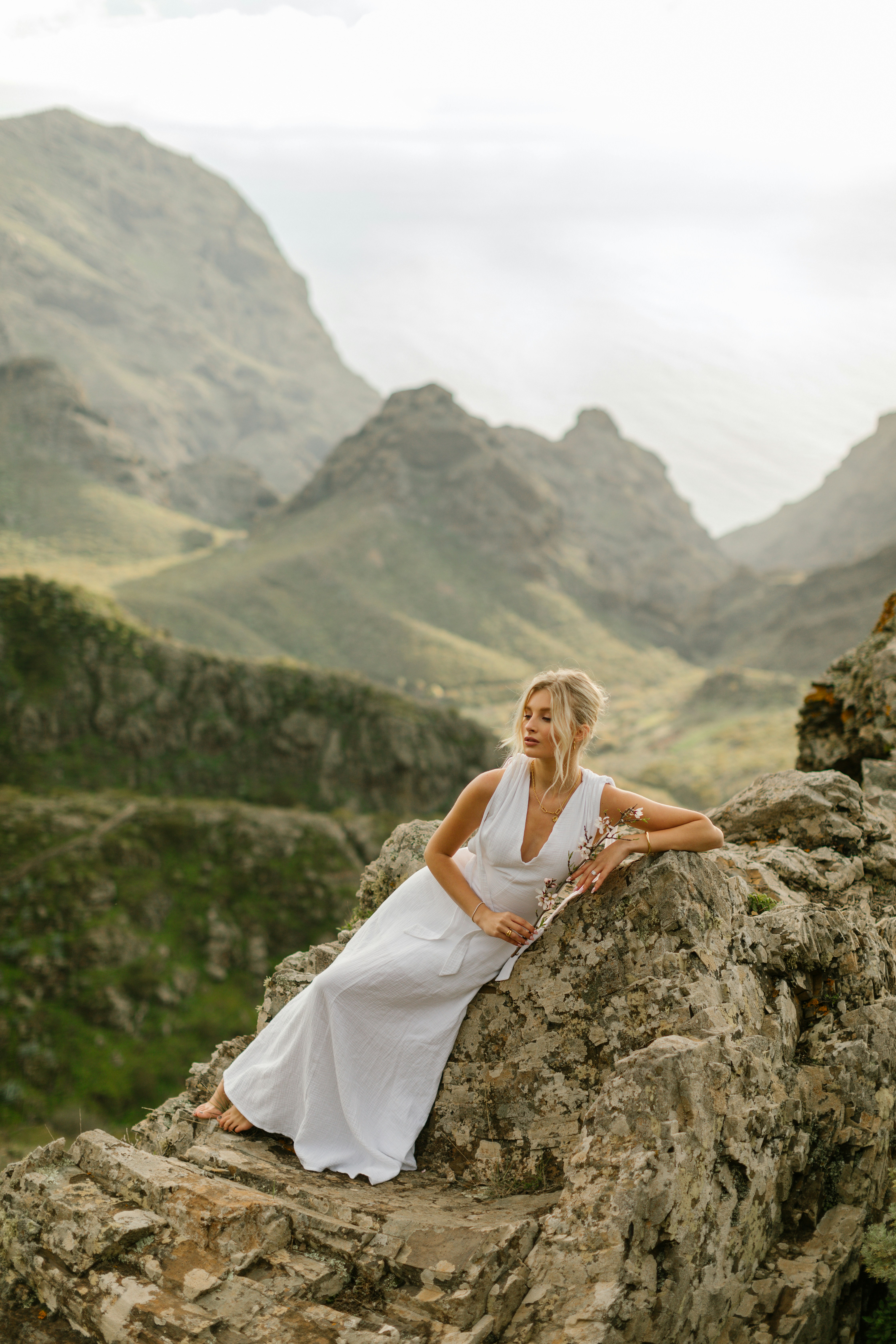 Silhouette on the Summit: A Bride in White among Rugged Peaks