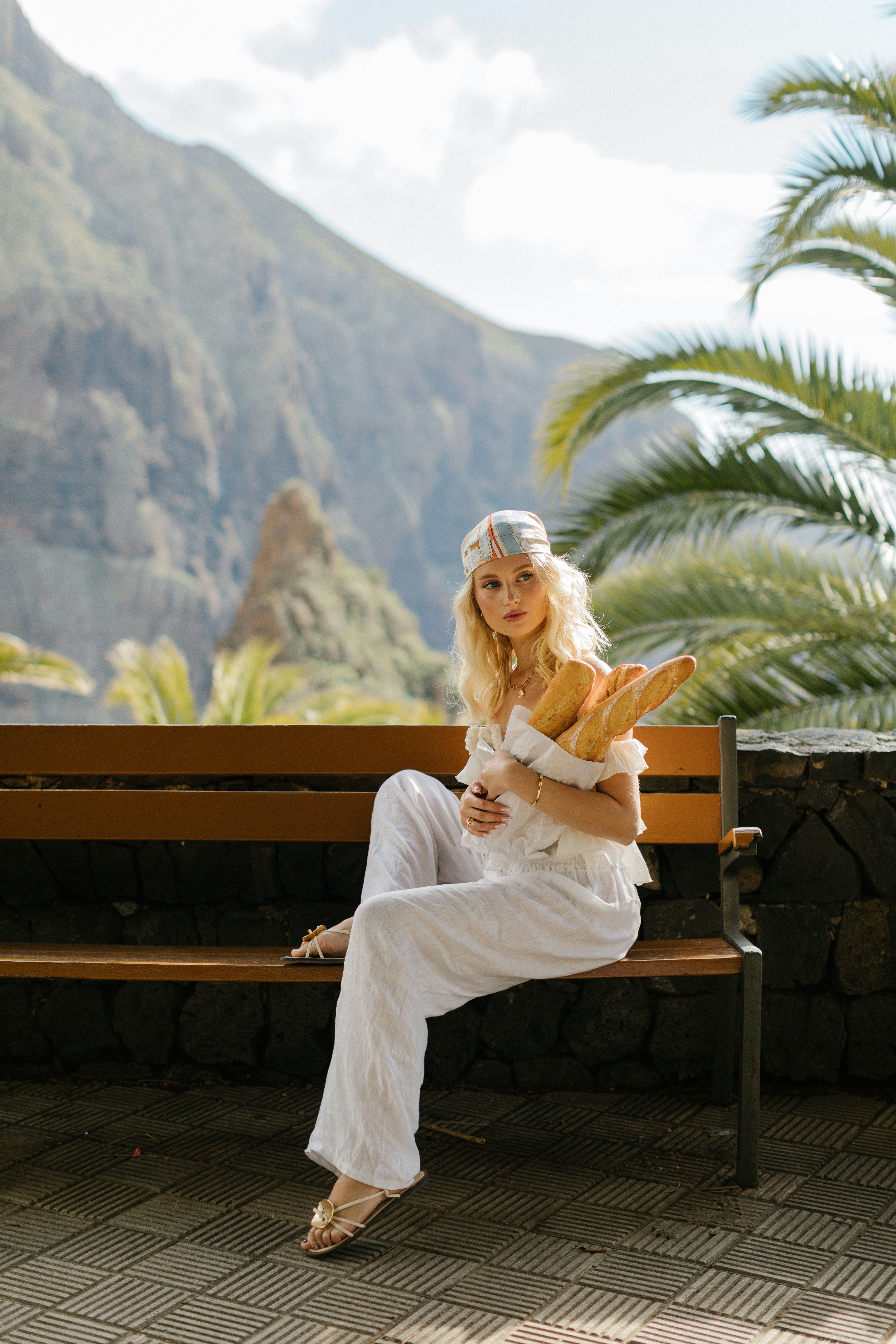 Blonde Street Vendor on a Sunlit Terrace with Baguettes
