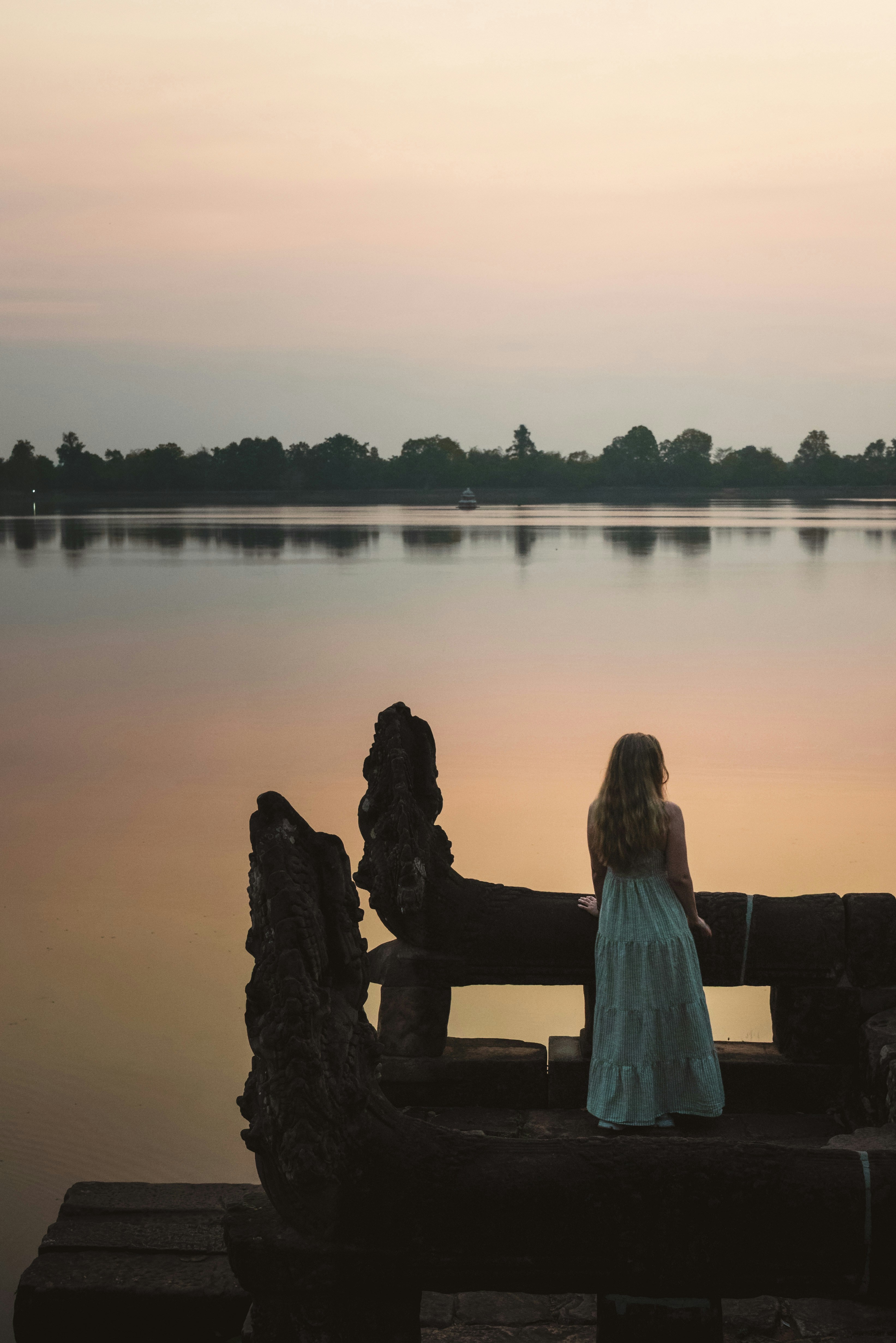 Silhouette on the Docks: A Quiet Sunset by the Water