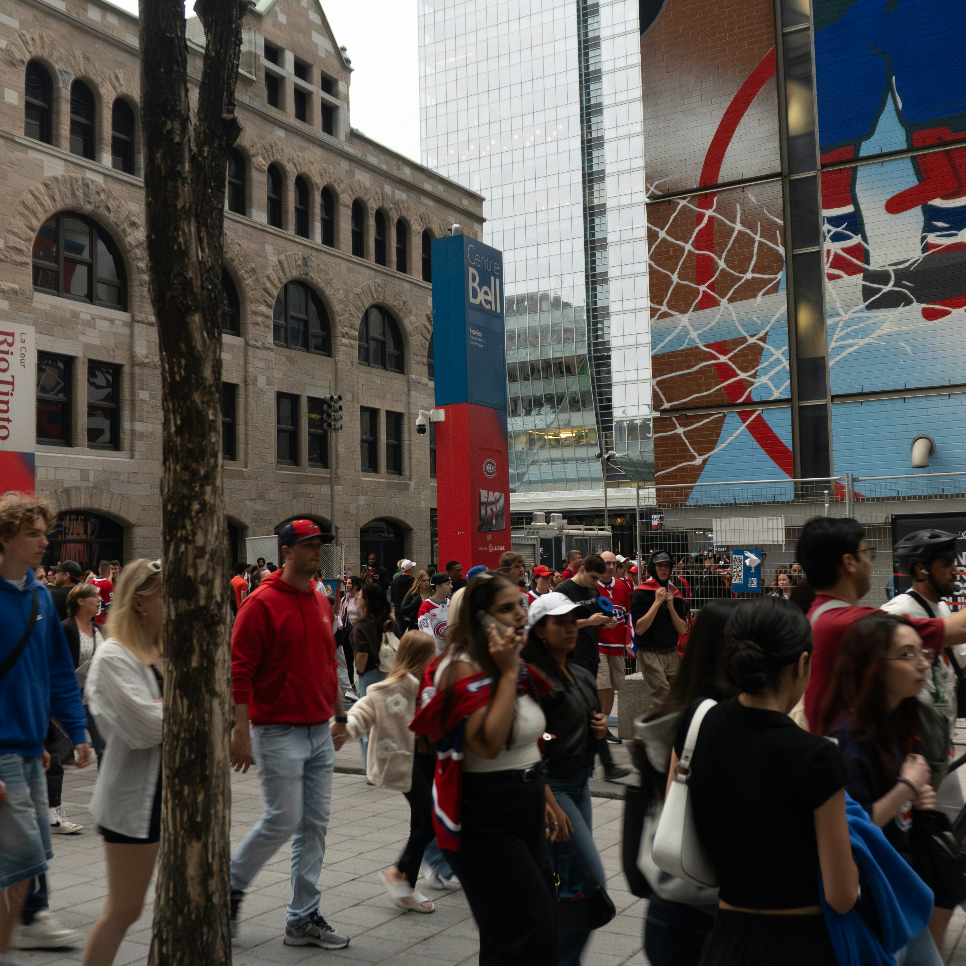 City Crowd Converges Under Modern Mural
