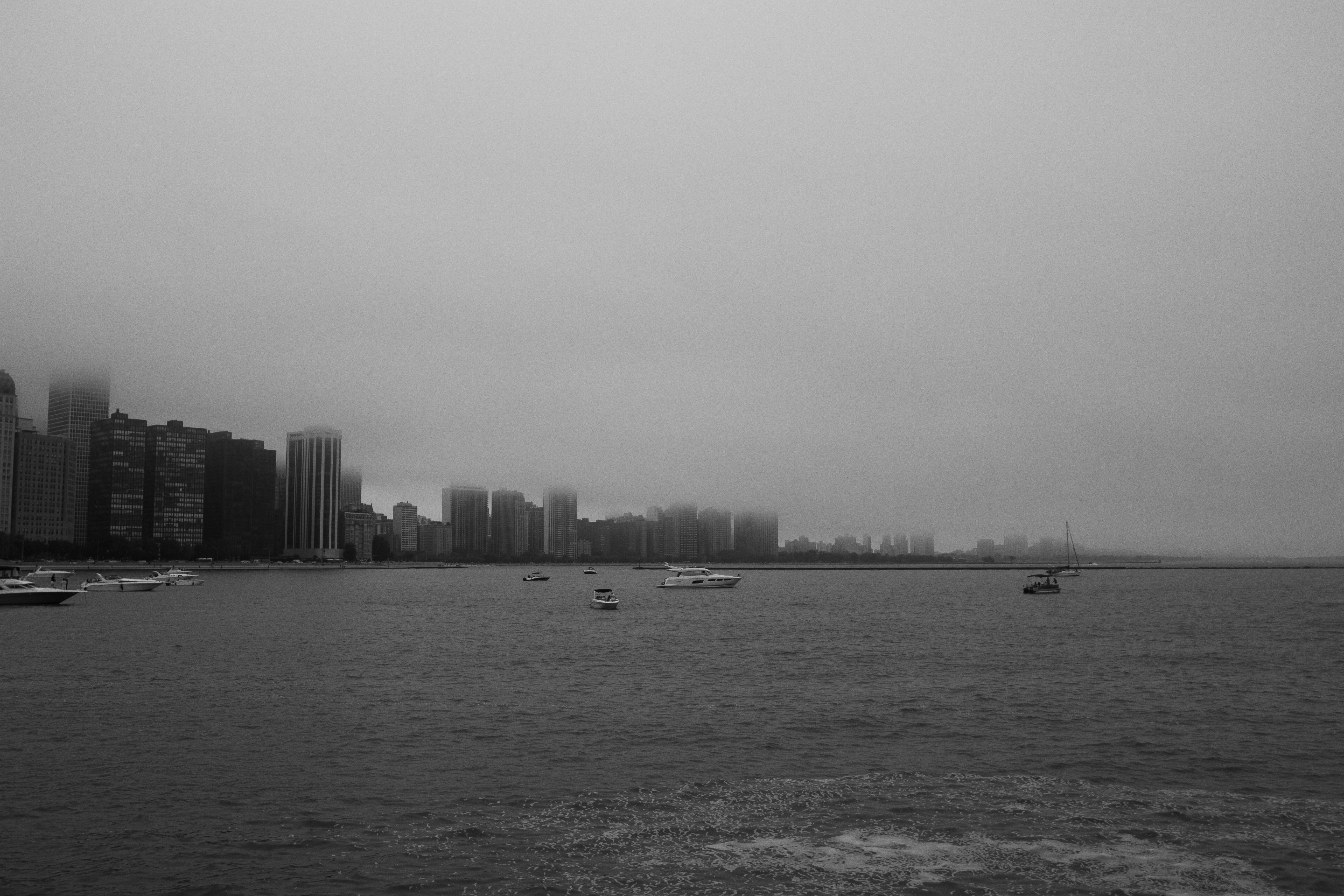 Fog over the harbor: city silhouettes fading into mist