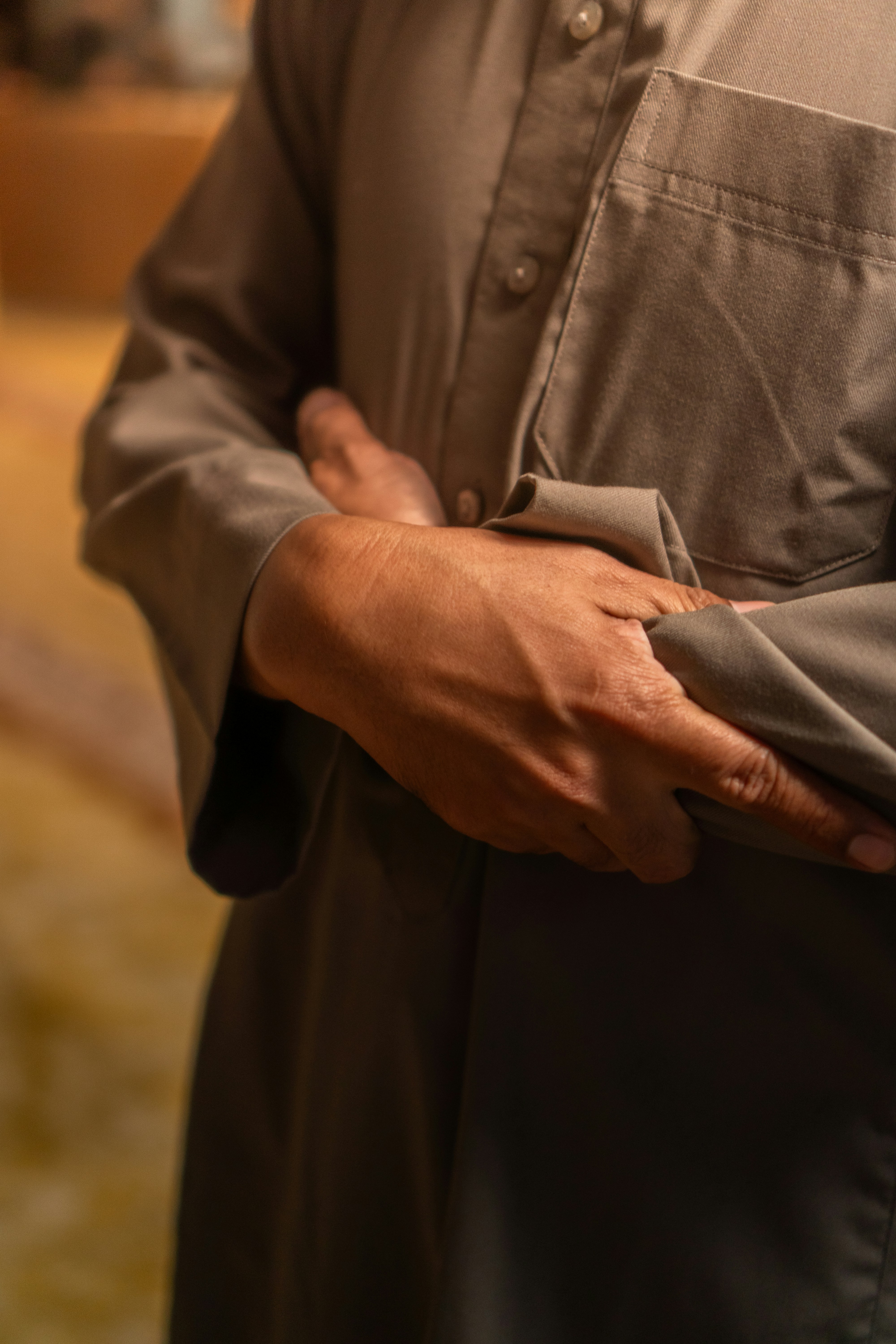 Hands Folded, Quiet Confidence: A Portrait in Warm Tones