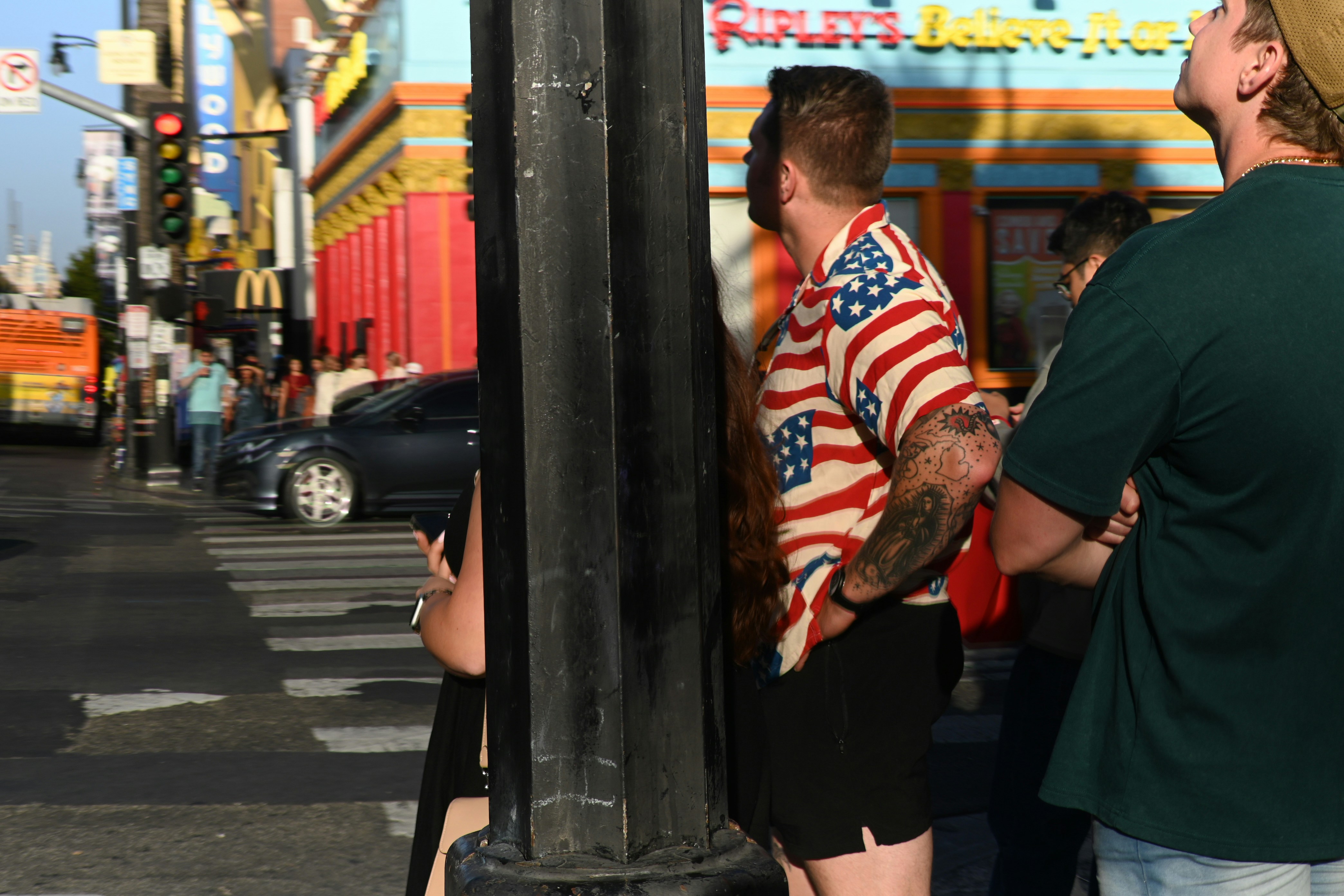 Crossroads of Color and Crowd: Portrait by a Streetlight