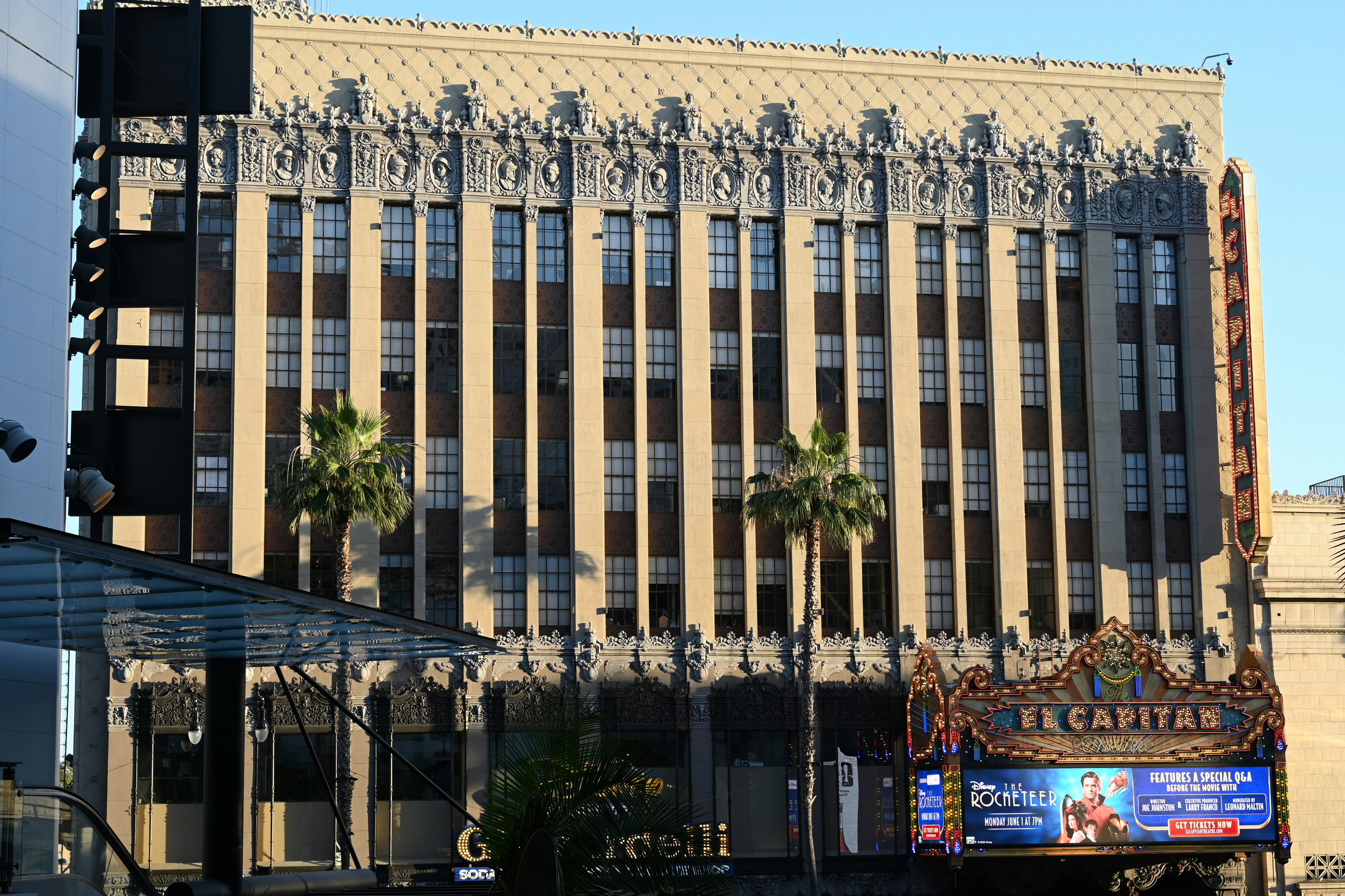 Sun-Soaked Theater Façade: Classic Architecture with Neon Signage