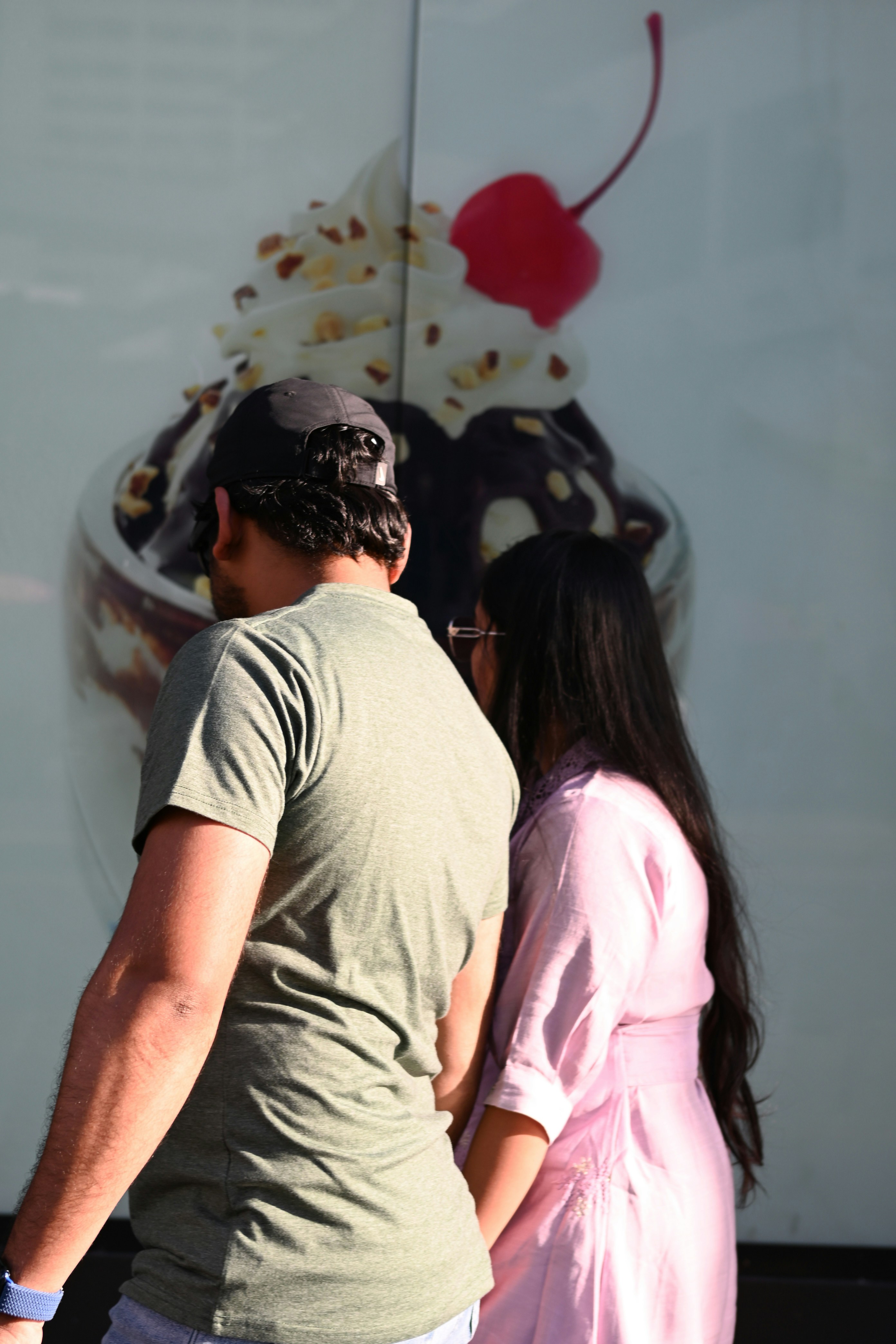 Shared Moment in Front of a Sweet Backdrop