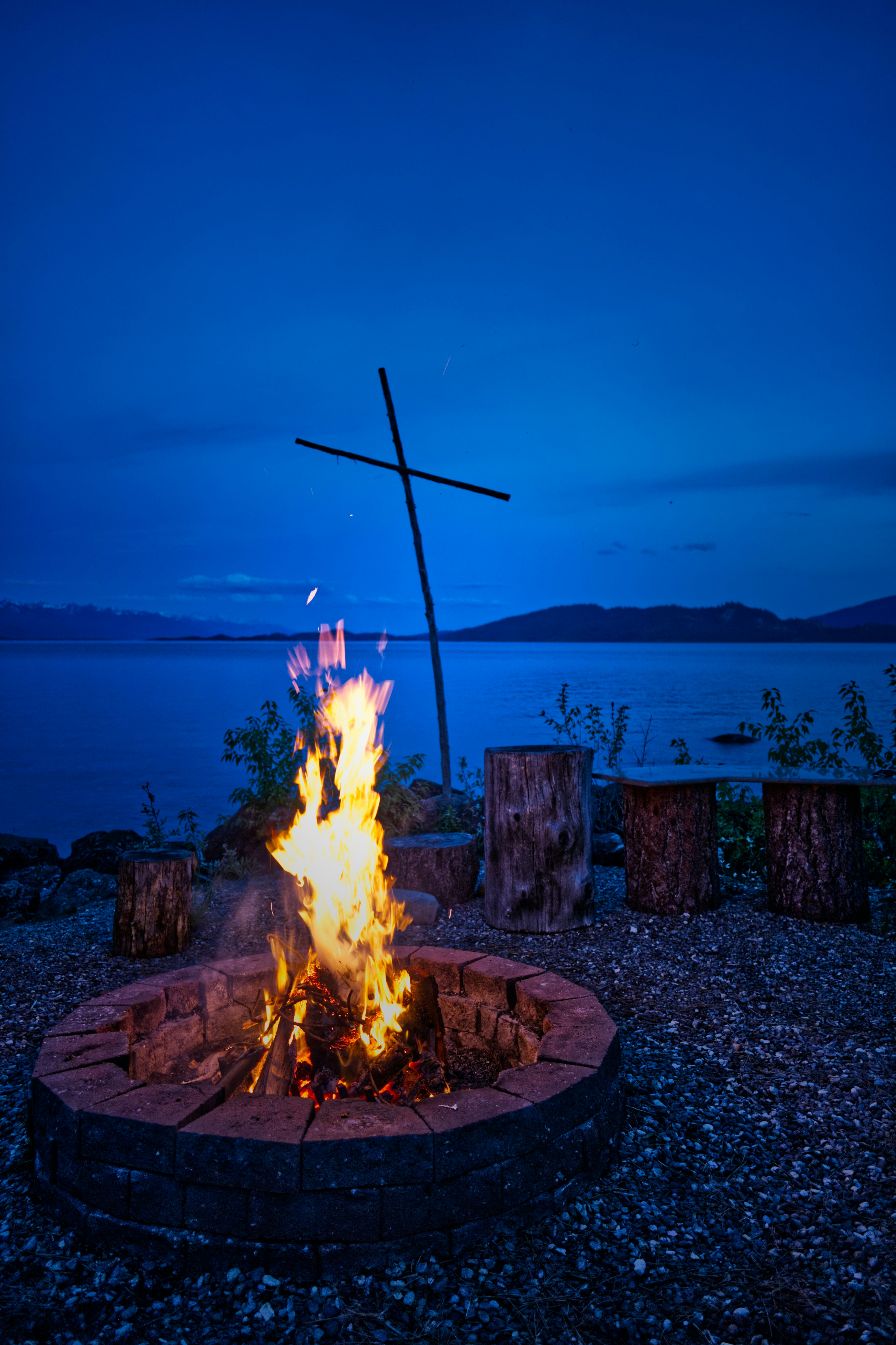 Firelight by the Shore: Cross atop the Quiet Evening