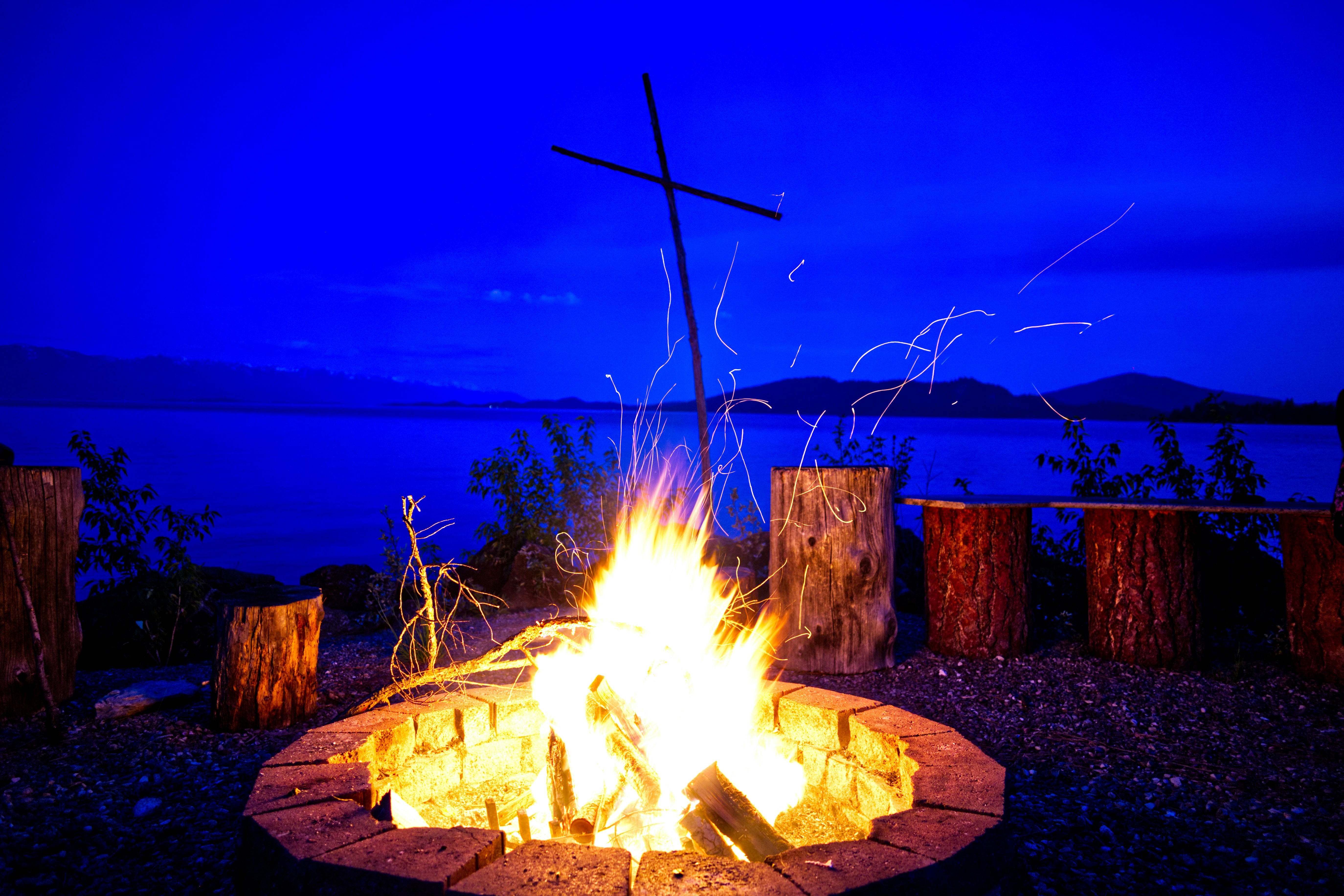Firelight on the Water: Lantern Flames Mark the Night Shore