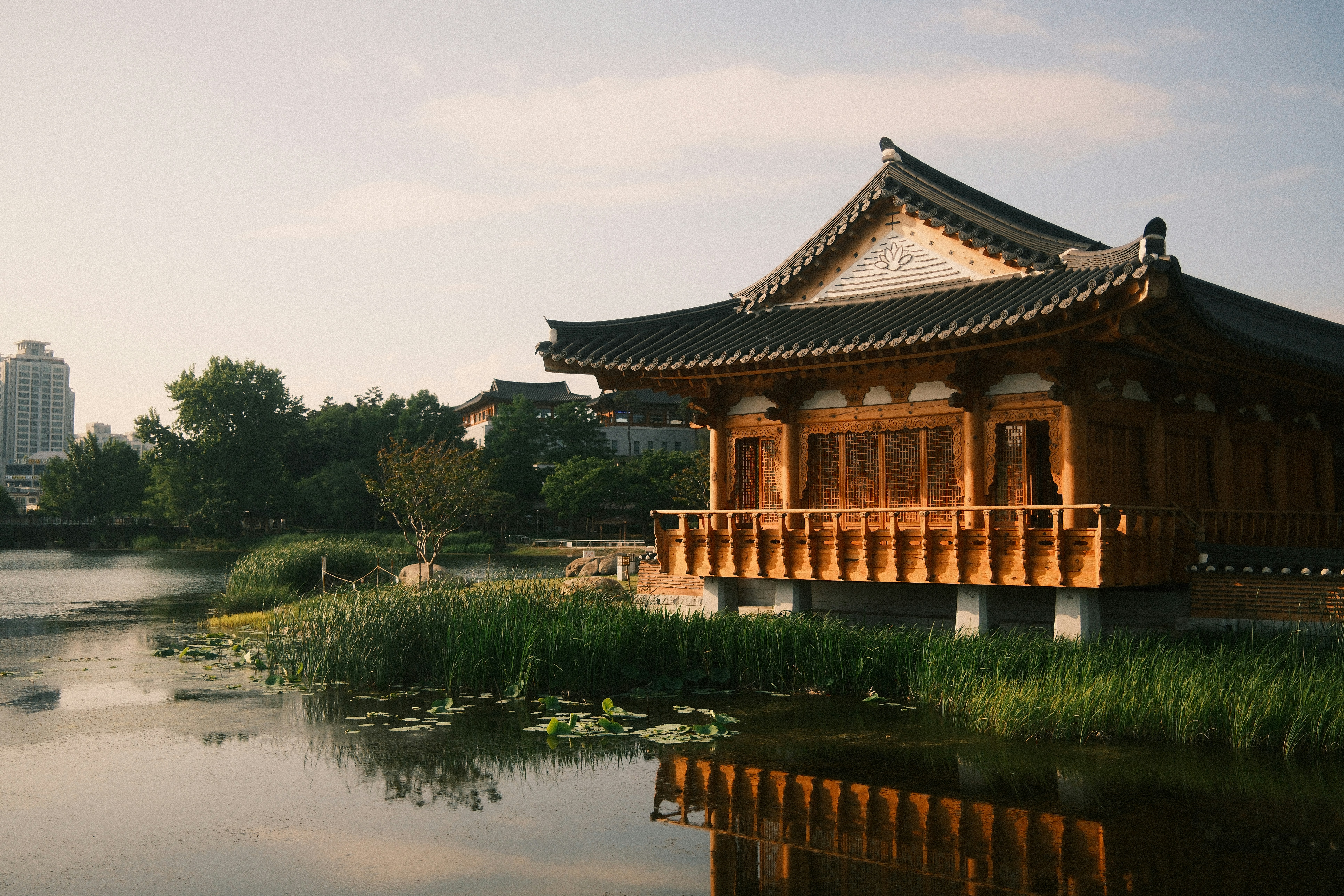 Golden Pavilion by the Pond: A Traditional Resting Hall in Sunset Light