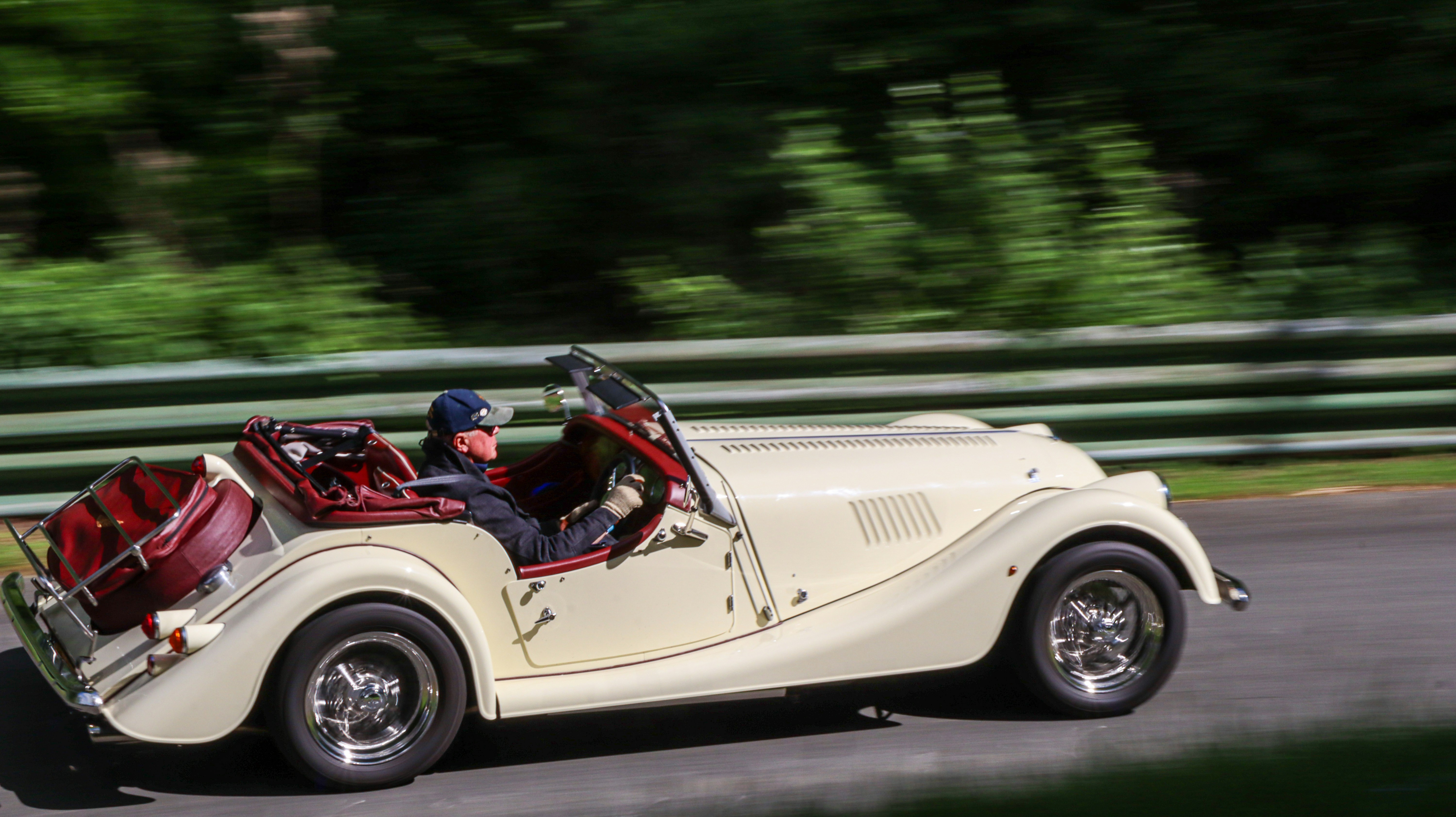 A Cream Classic in Motion: Sunlit Convertible Racing Down the Road