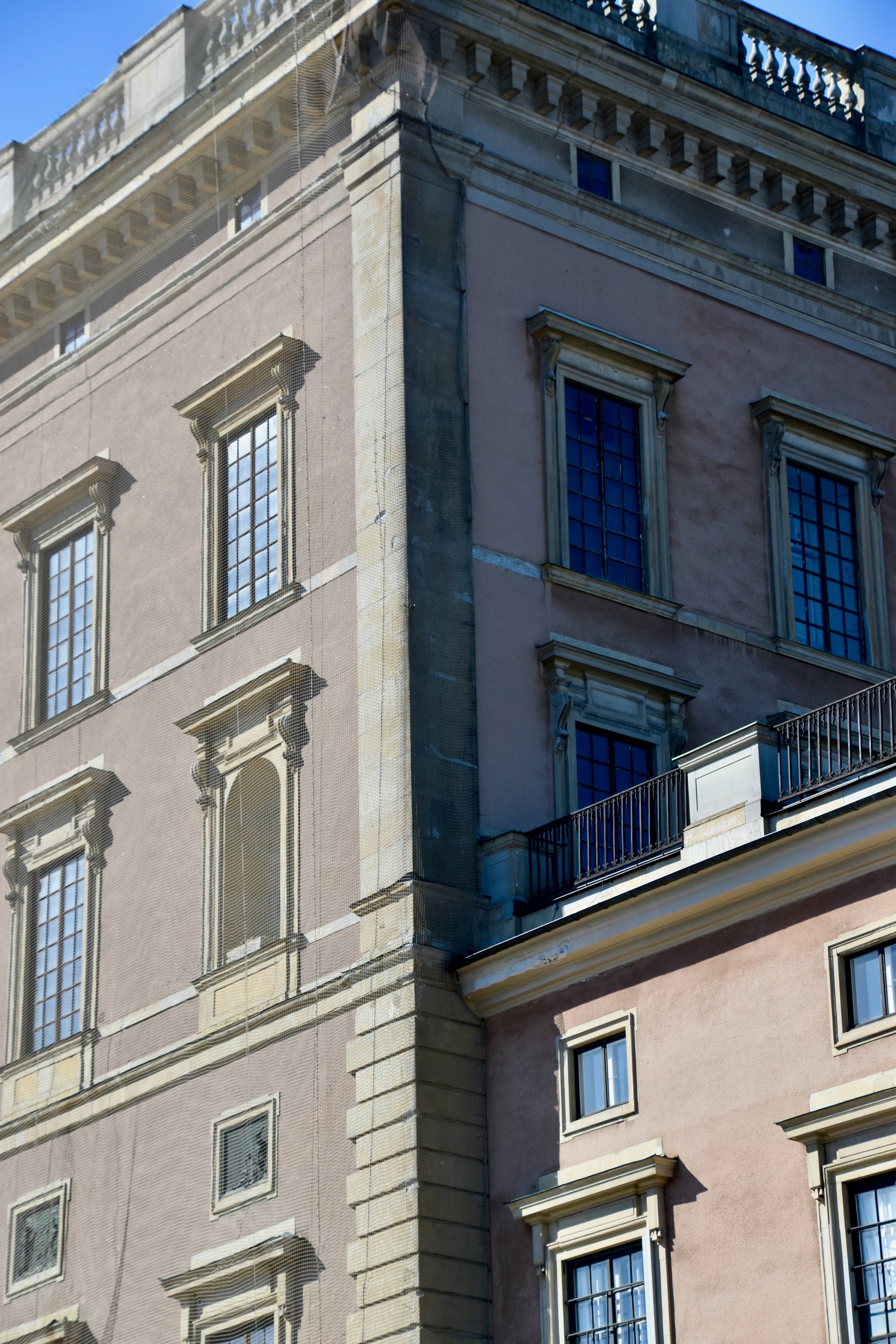 Corner of a Historic façade: sunlit shutters and architectural detailing