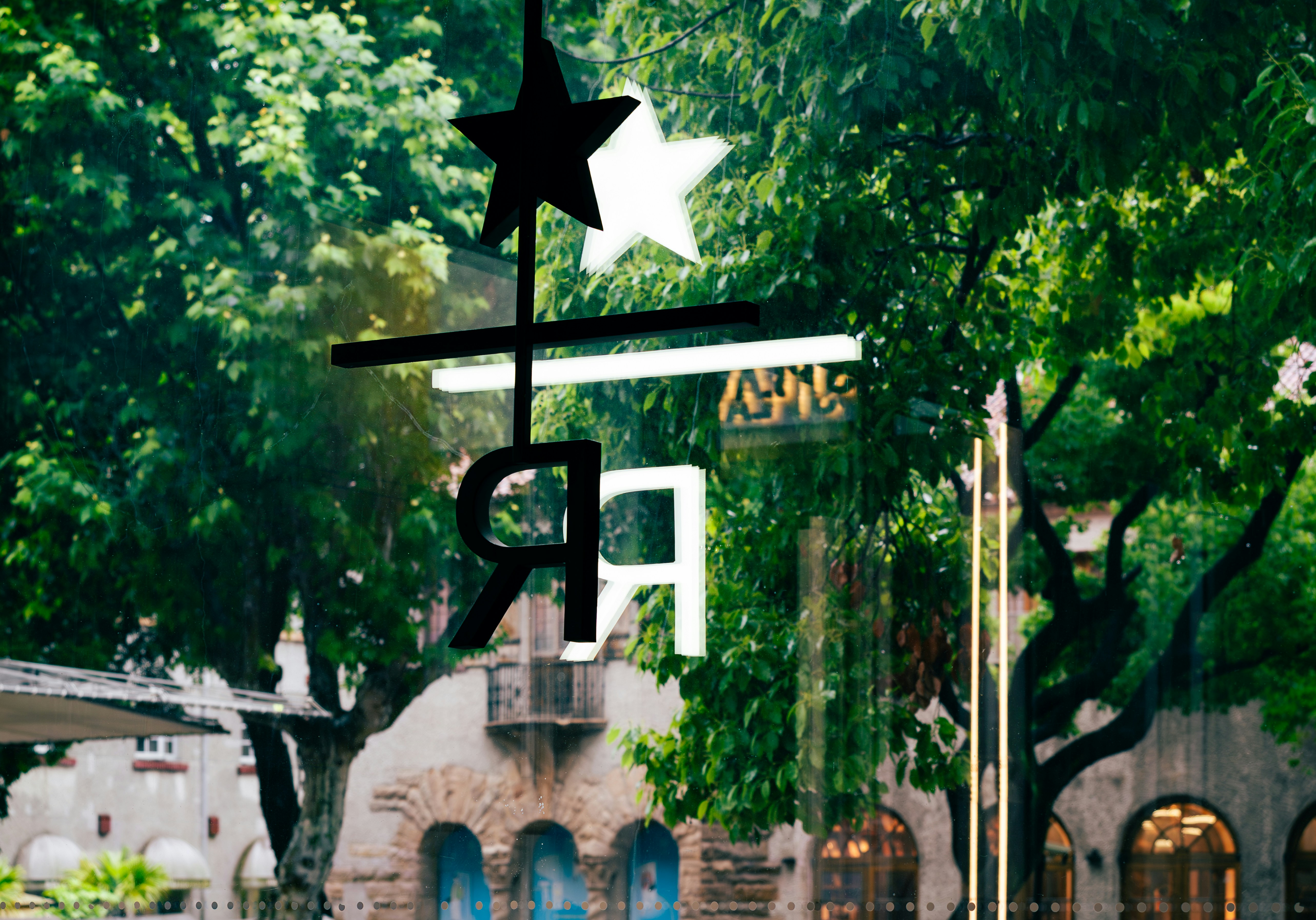 Pop-in Reflection: Framed City Life Through a Glass Emblem