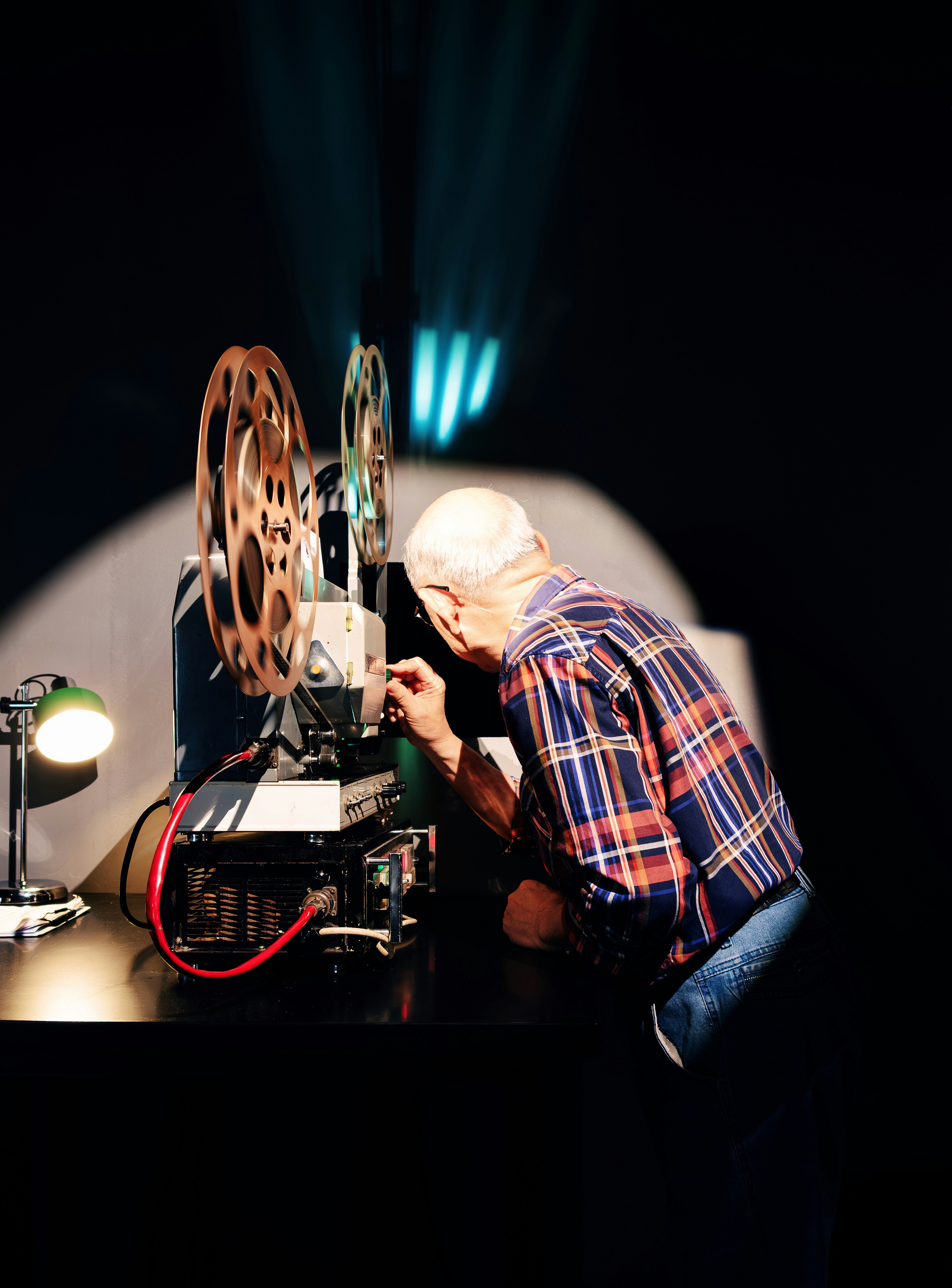 Senior Filmmaker at Work: Reel-to-Reel Precision in a Dim Studio